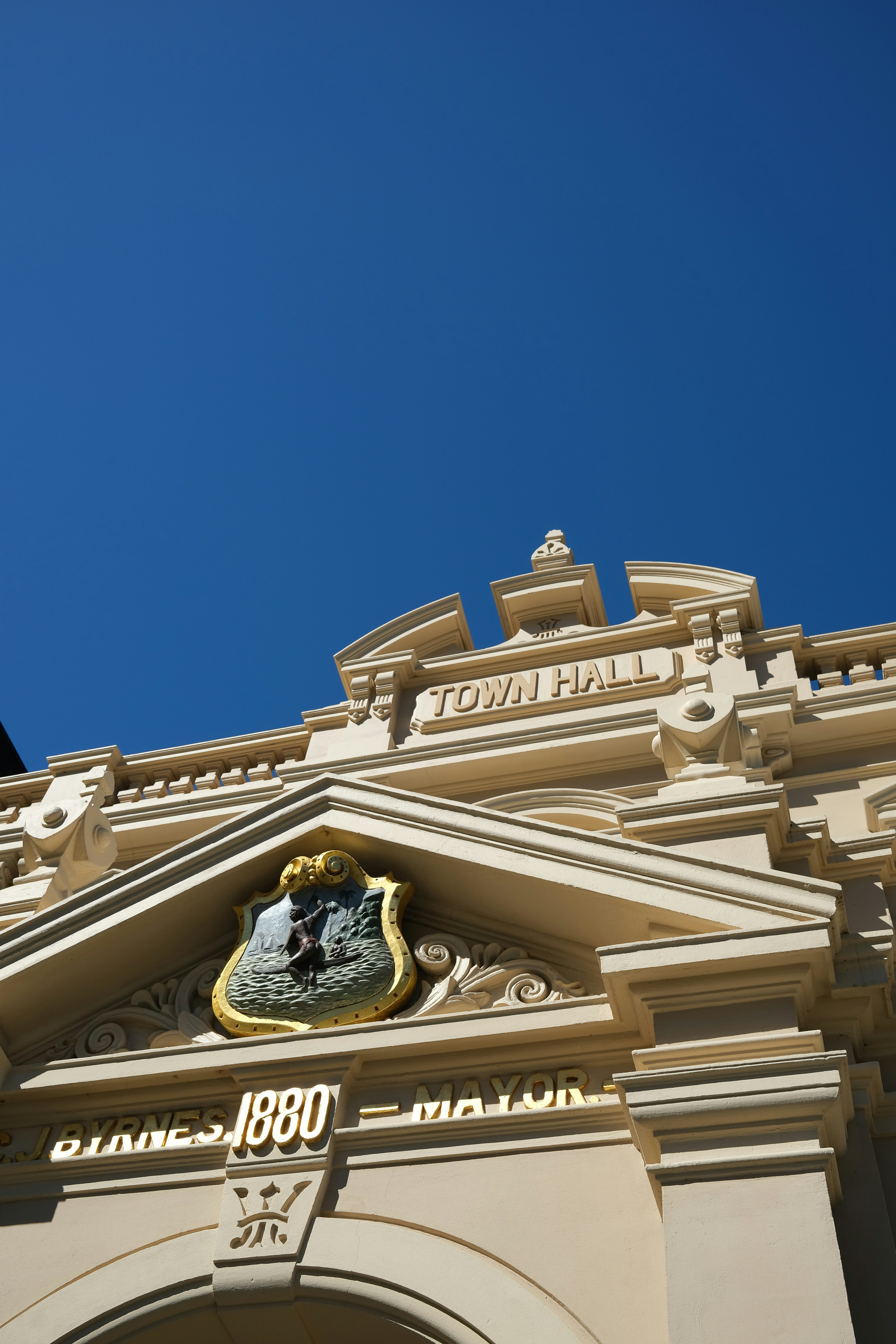 Town hall signage against a vibrant blue sky.