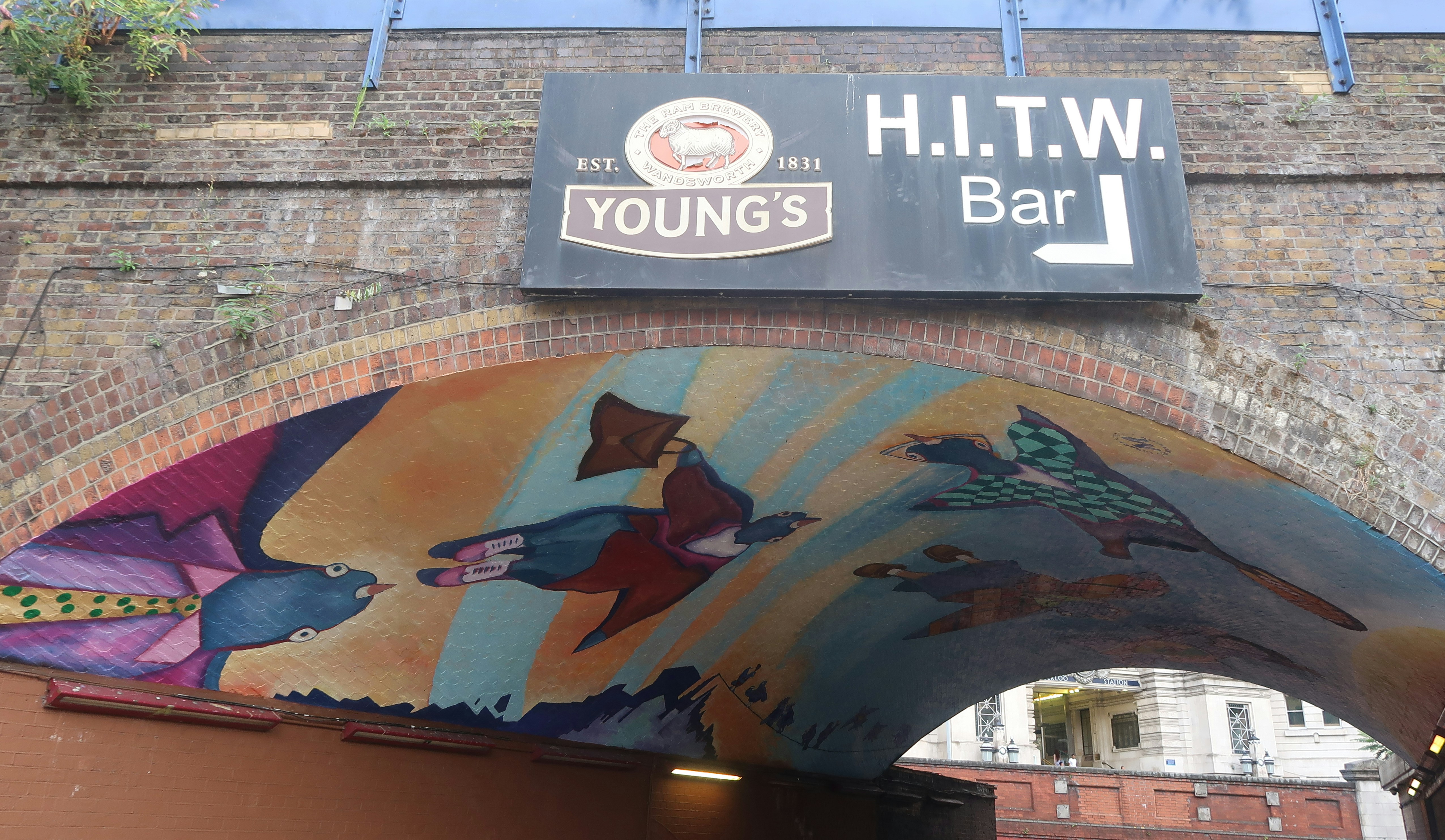 A young's bar is located under a bridge.