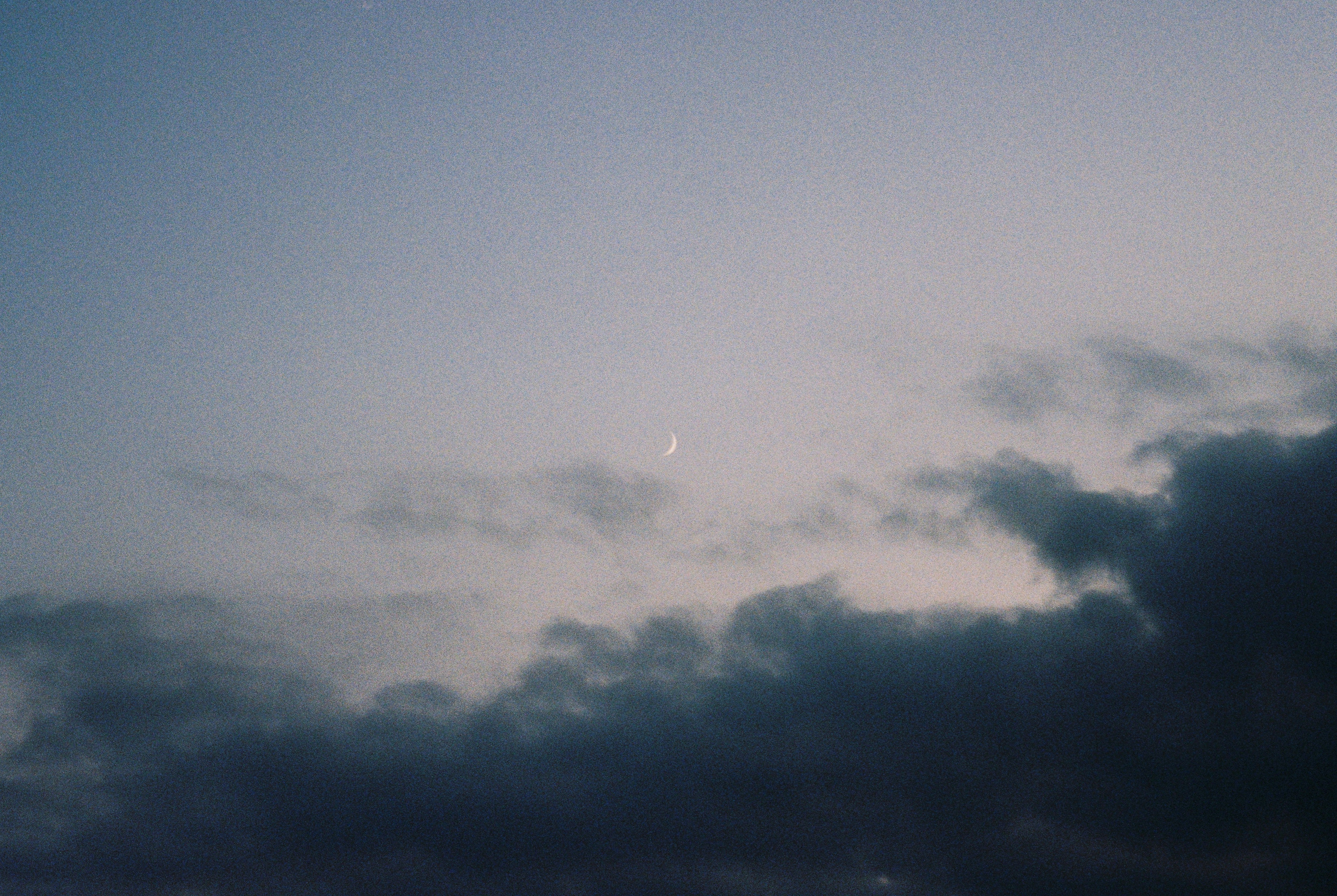 Shot on Kodak Gold 200 | Moon and clouds drift across a dusky sky.