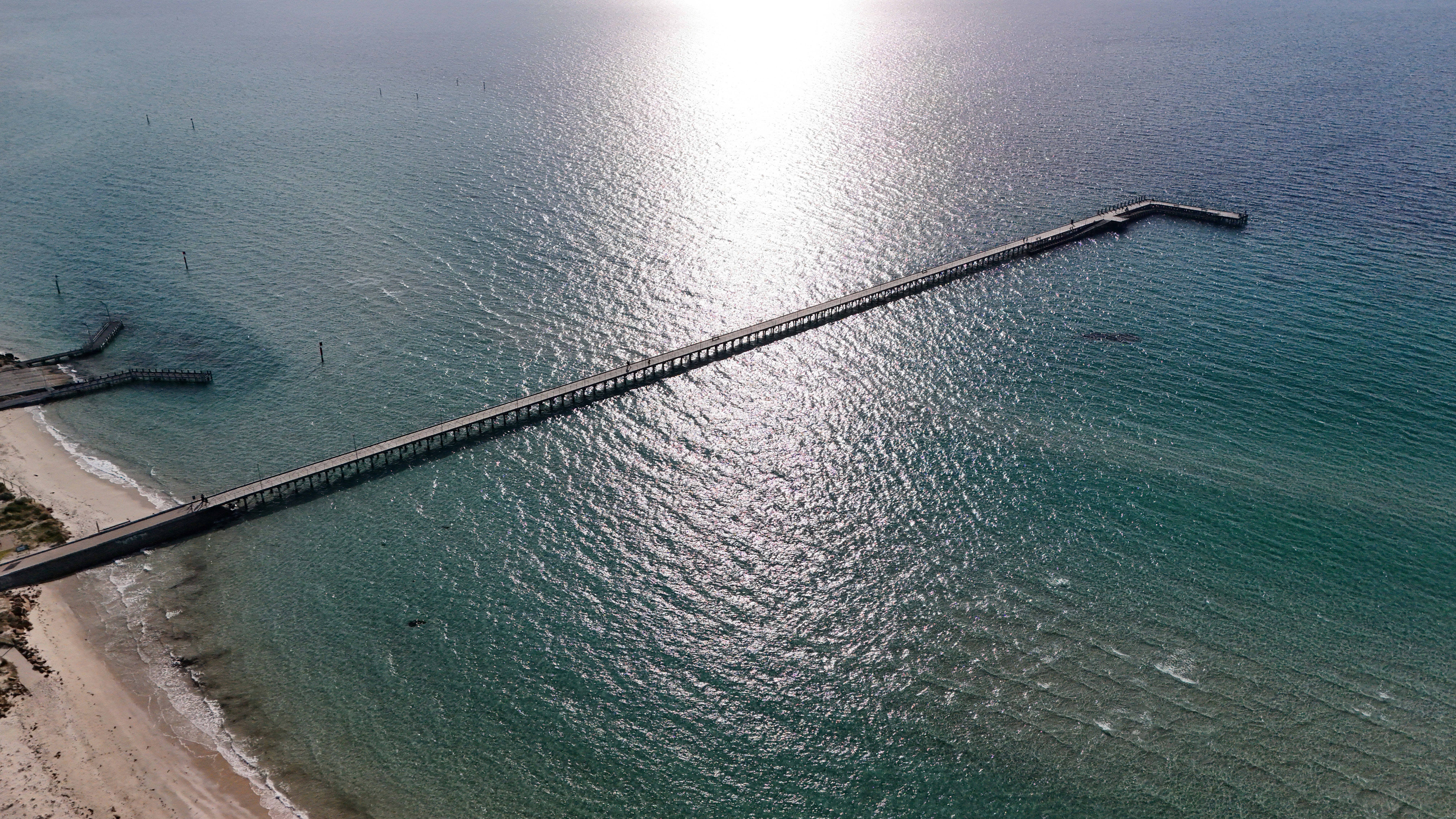An aerial view shows a long pier.