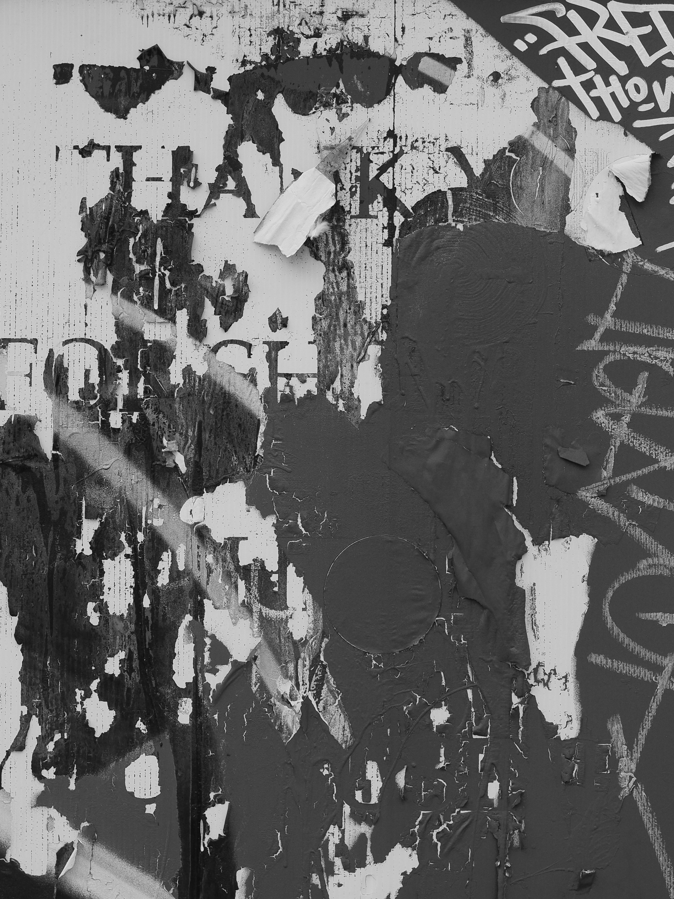 OLYMPUS DIGITAL CAMERA | Torn posters and graffiti on a wall.