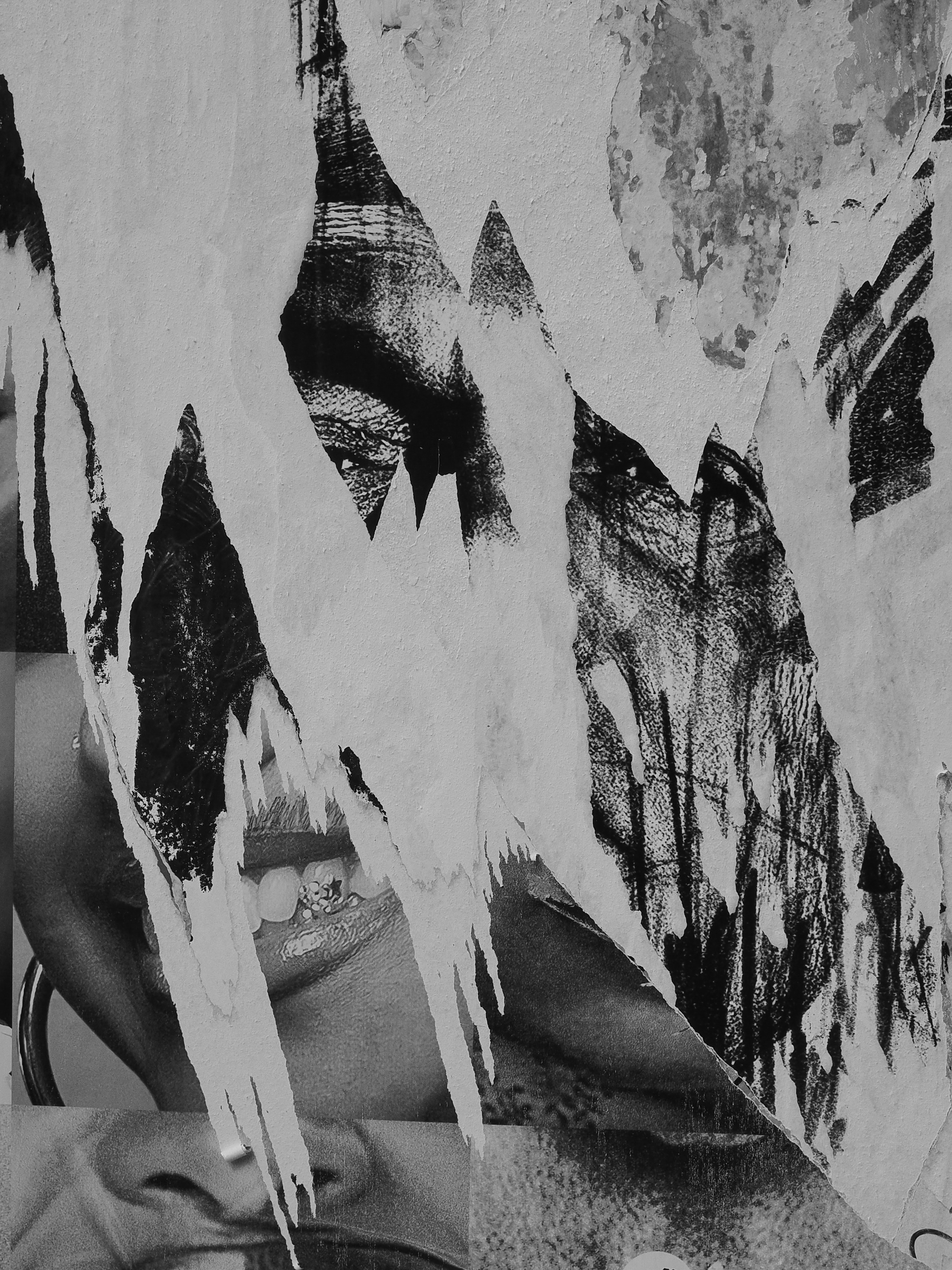 OLYMPUS DIGITAL CAMERA | Torn paper reveals fragments of faces.