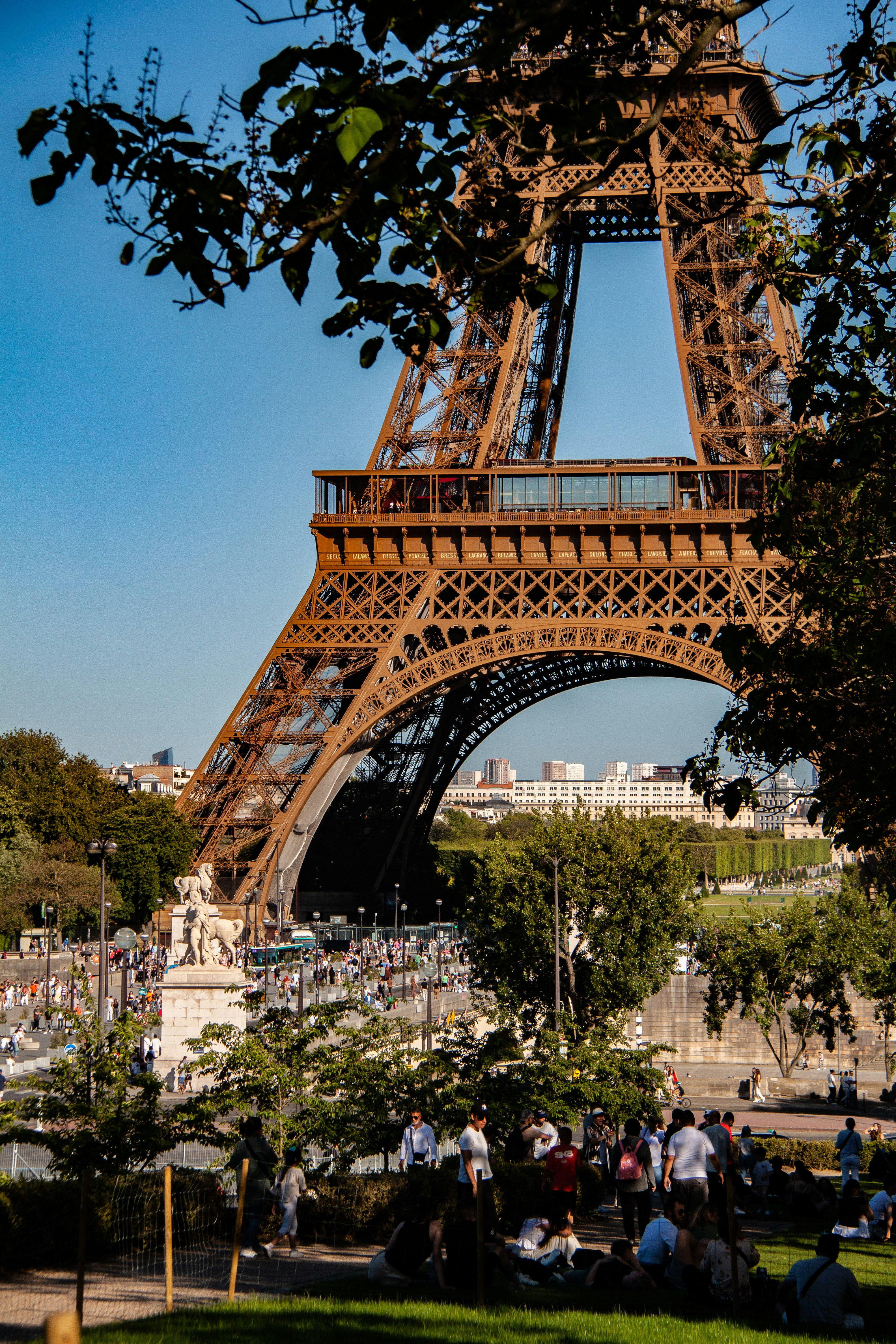 The eiffel tower towers over a crowded park. photo – Free Paris Image ...