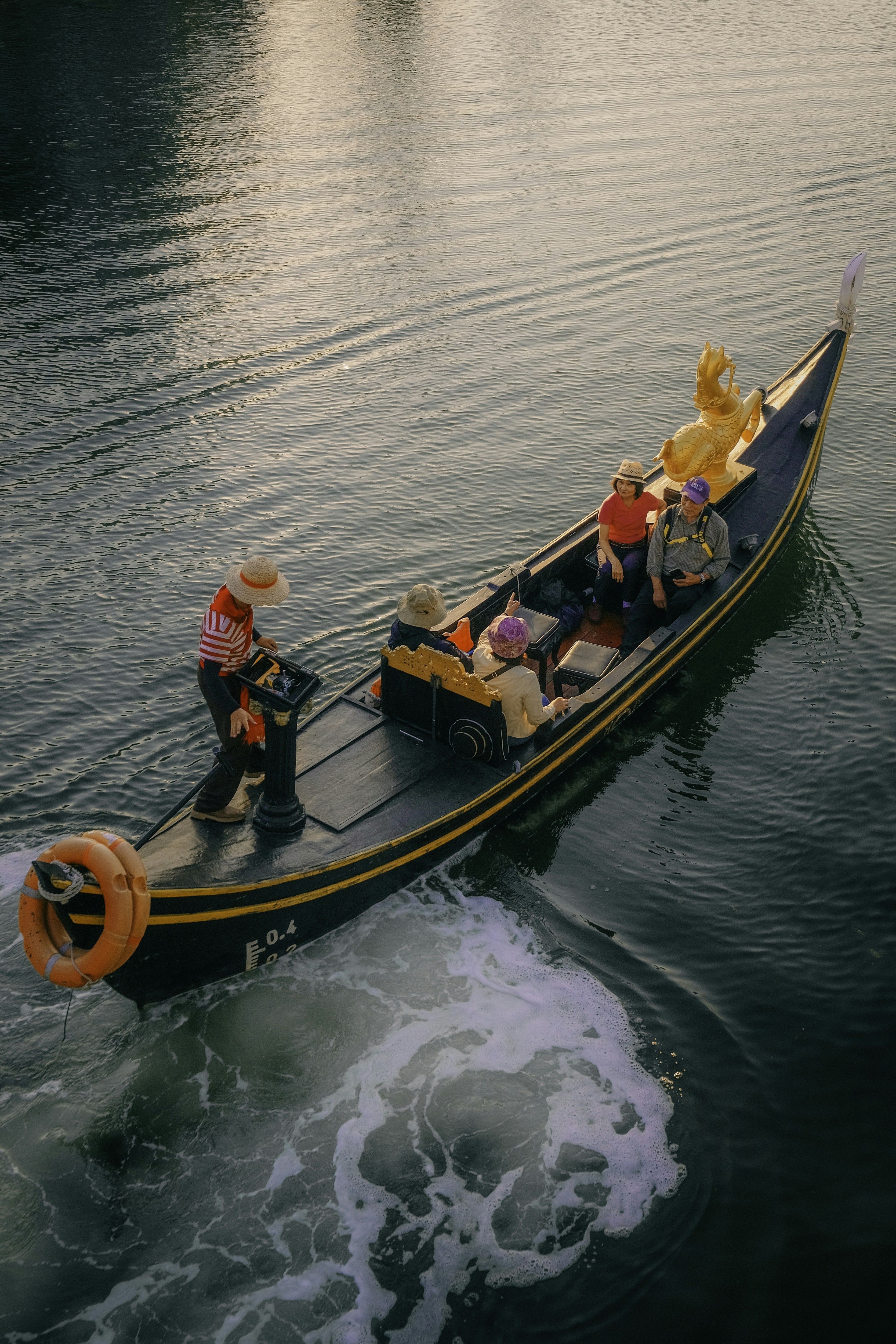 A gondola glides through the water with passengers aboard.