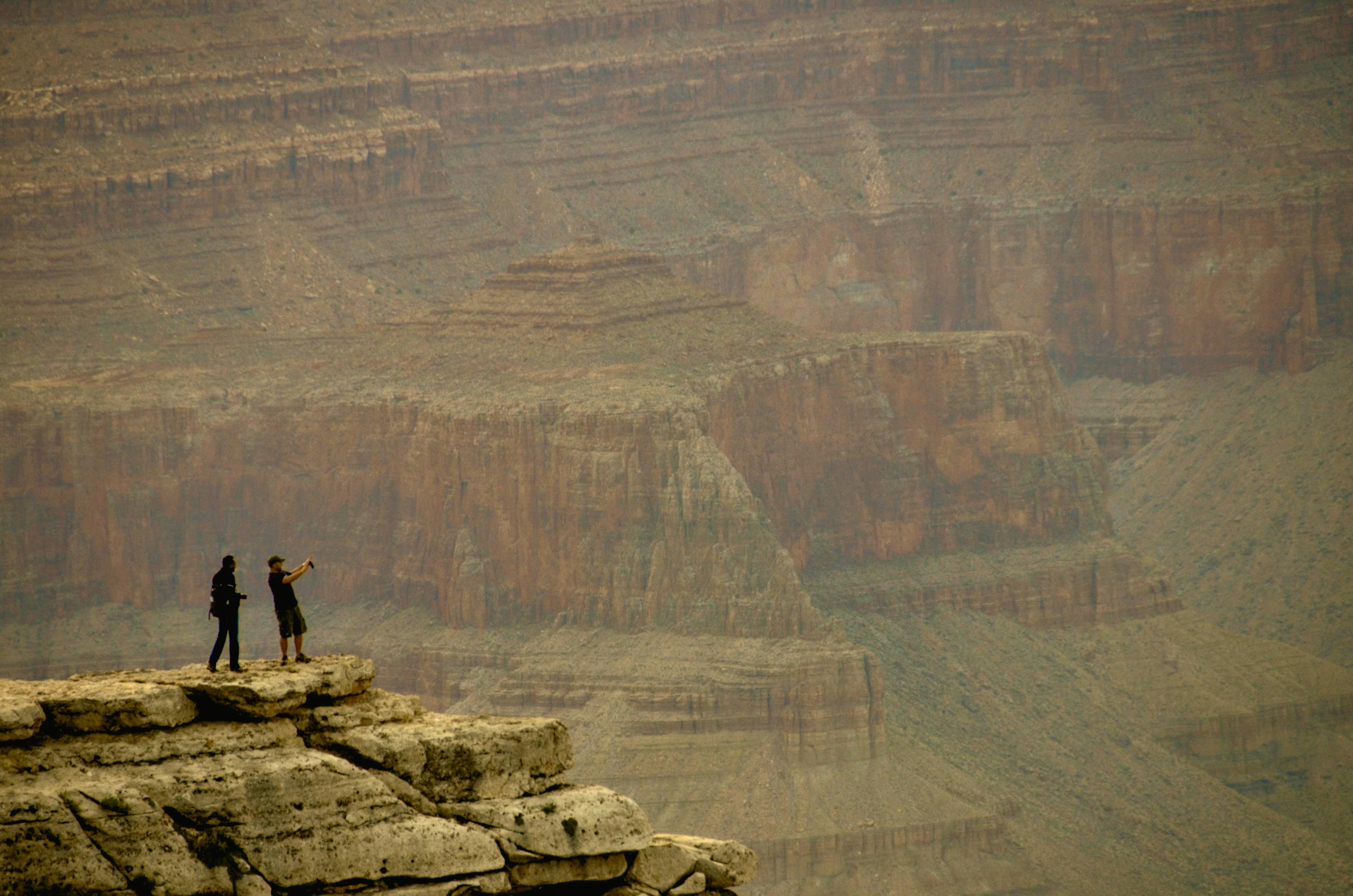 Grand Canyon, Nevada | Two people admire the grand canyon's vastness.