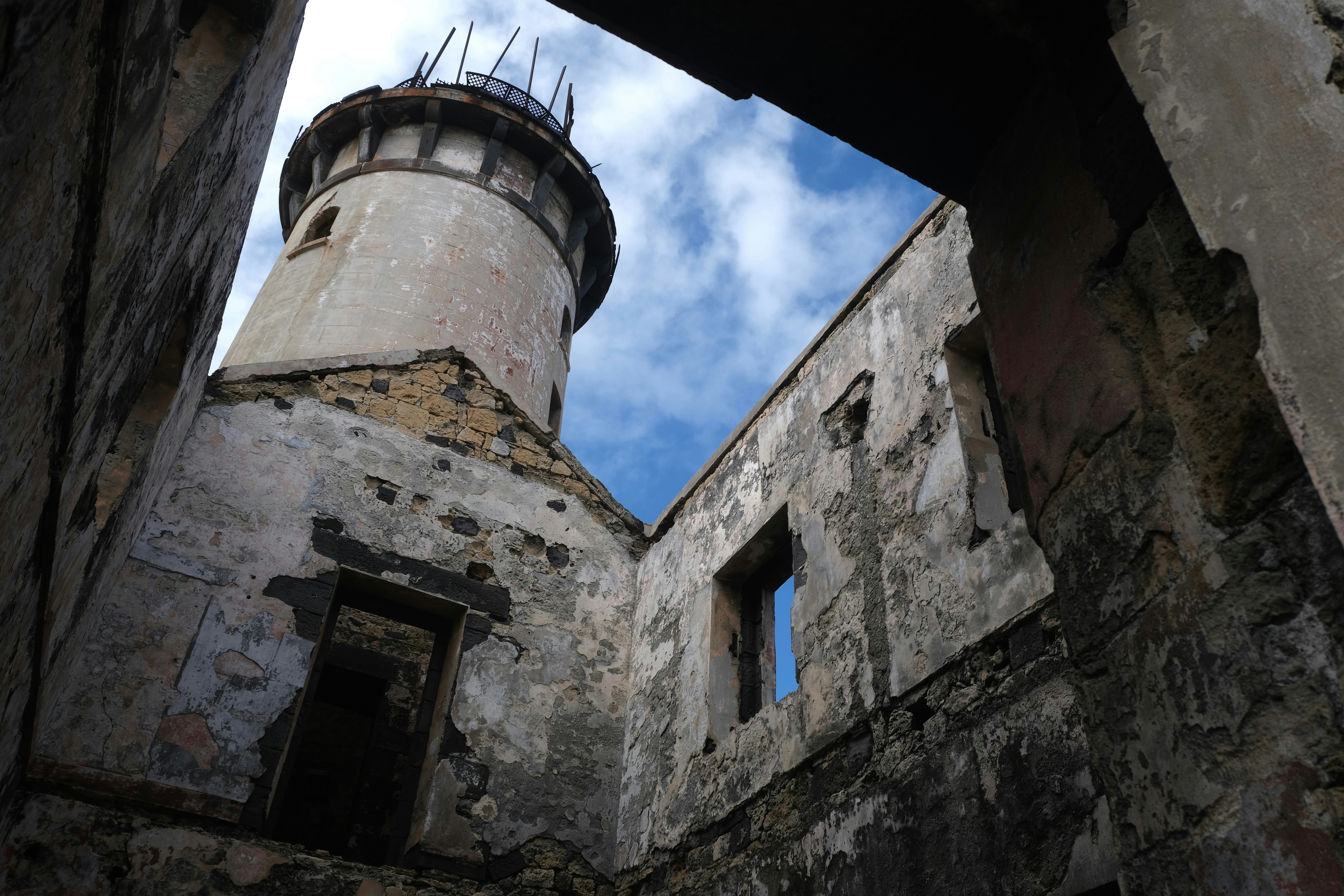 Faro di Ile aux Cerfs, Mauritius | A dilapidated building with a tower against the sky.