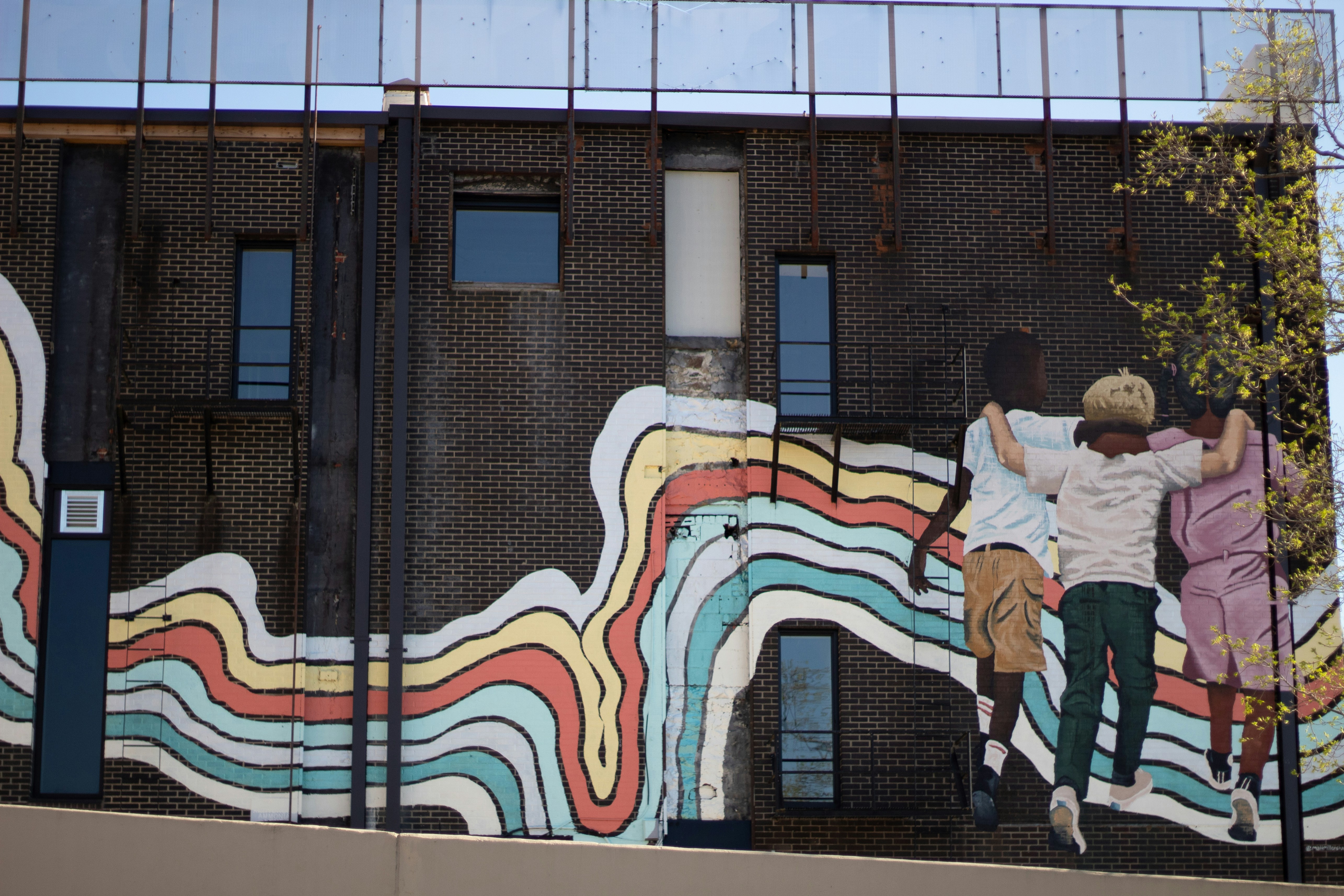 Mural by Matt Miller Studio | Mural depicts children jumping with colorful background.