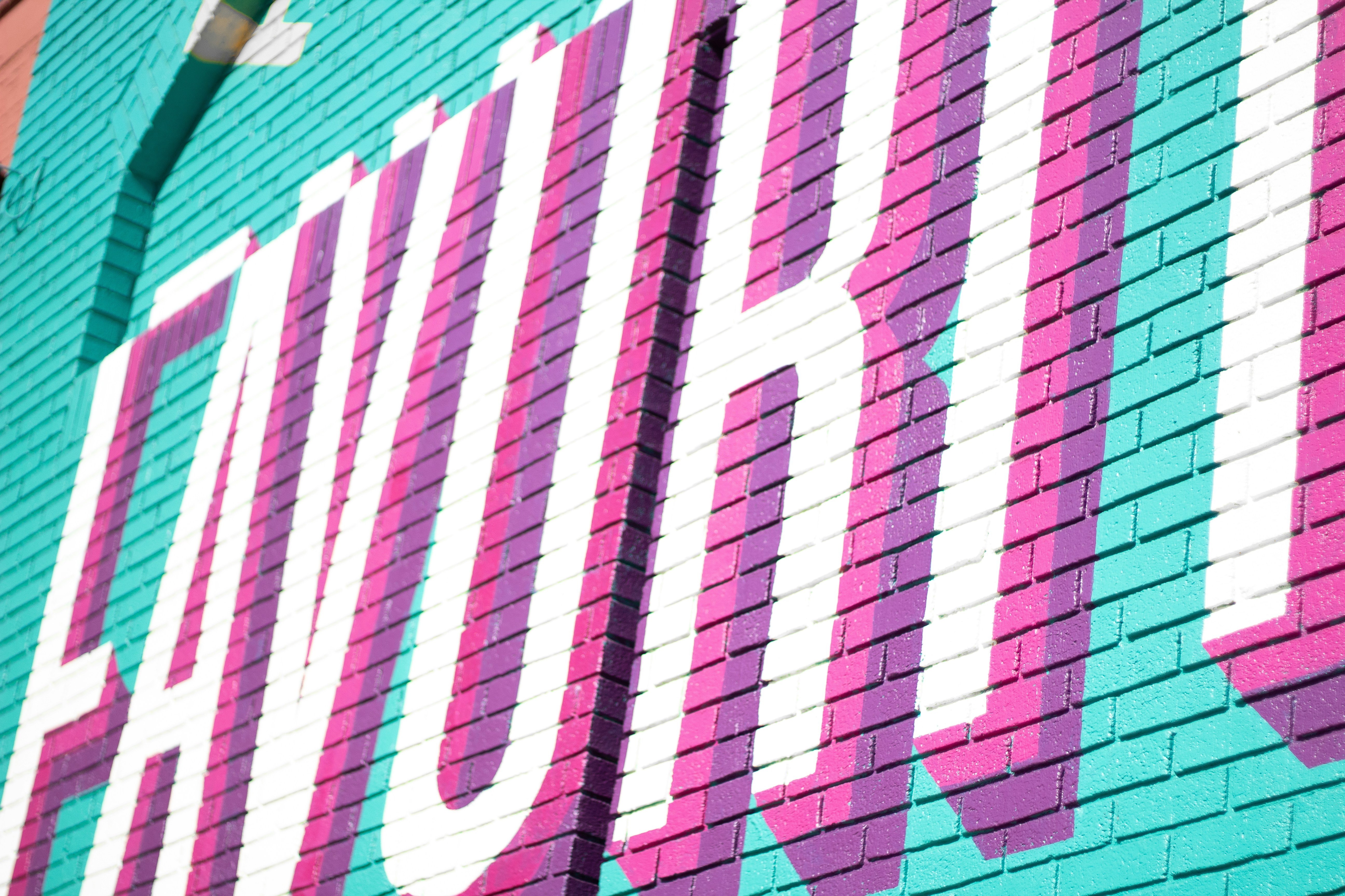 The word "favorite" is written on a brick wall.