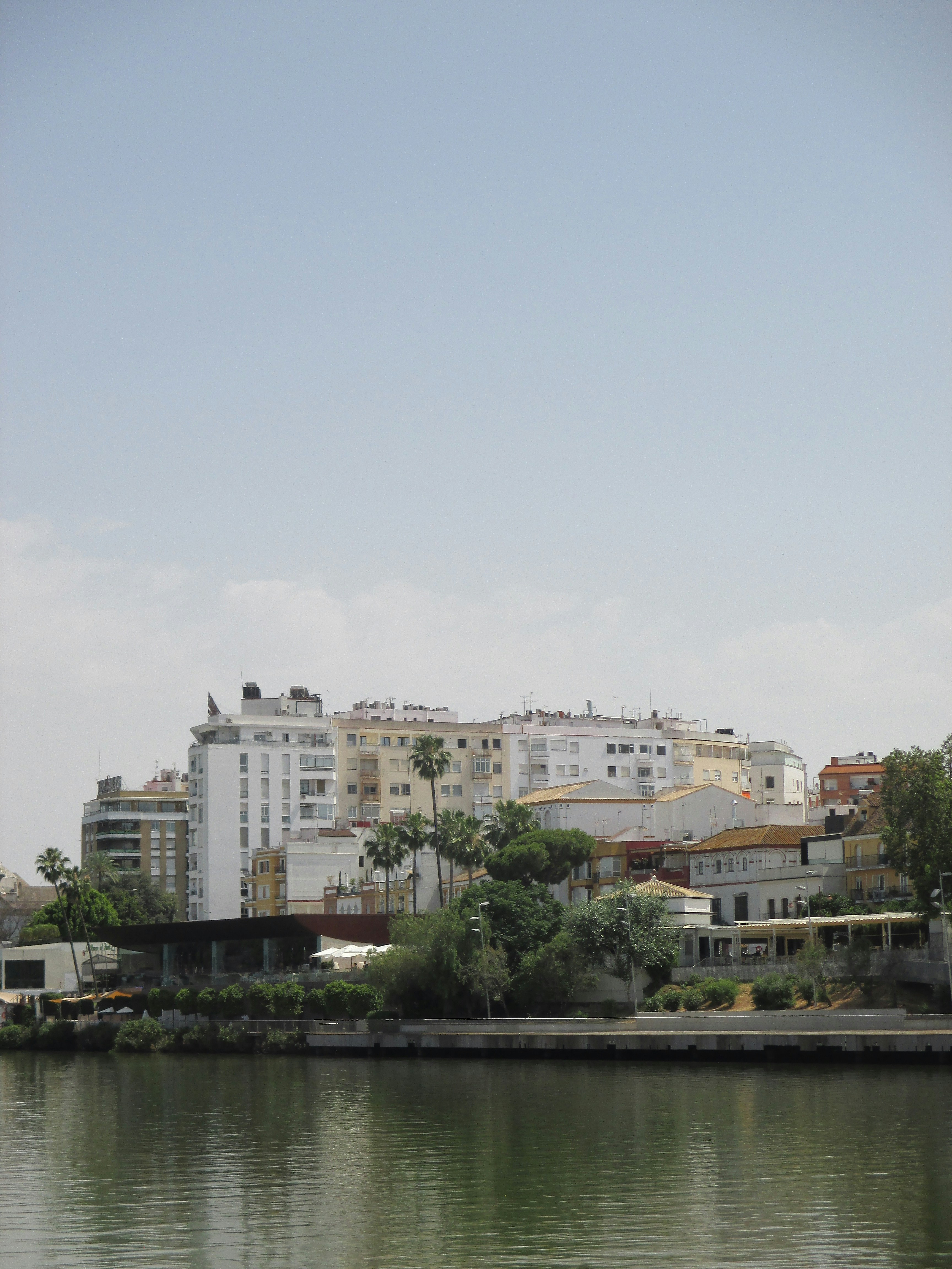 Buildings are viewed across the water.