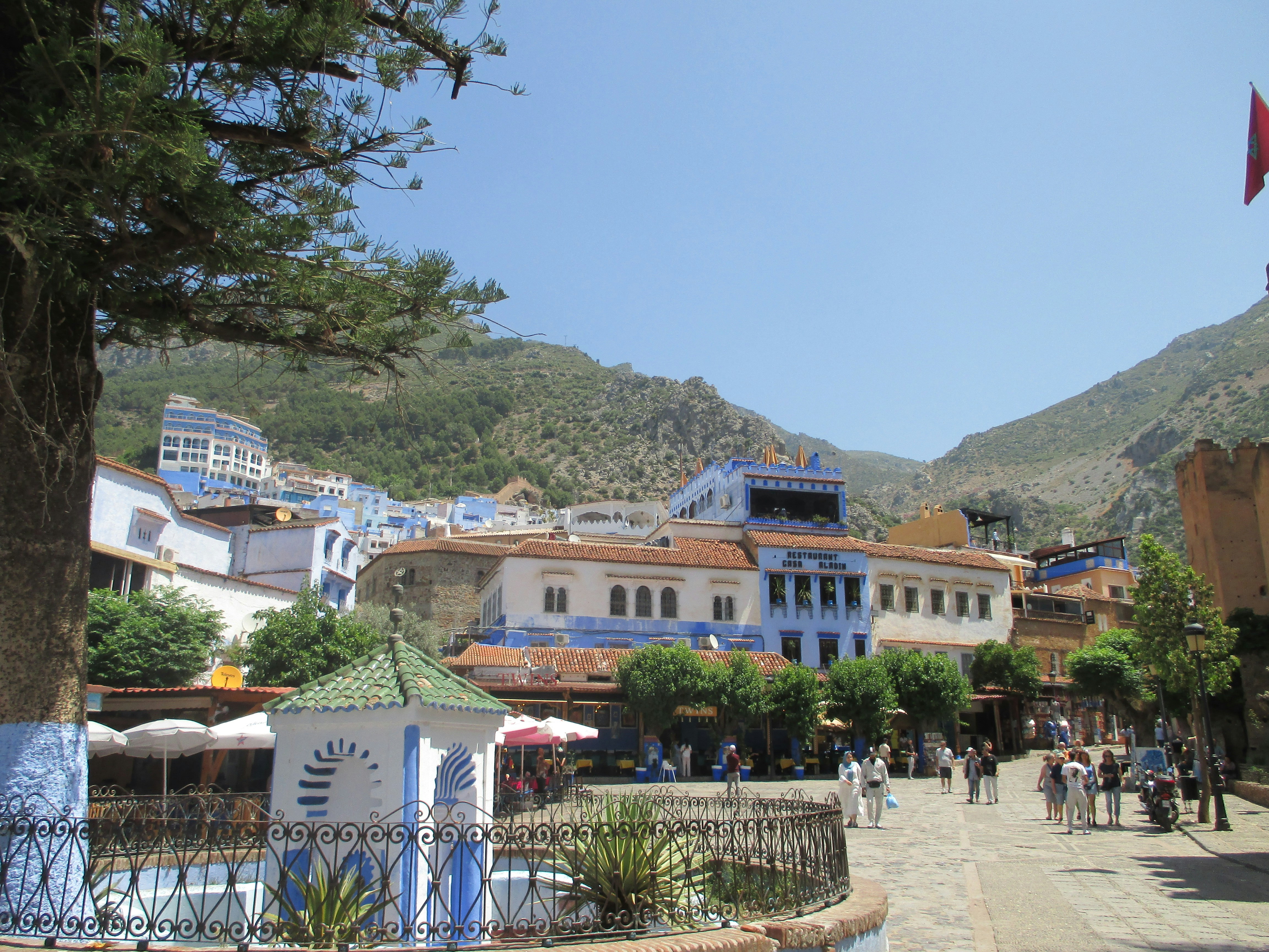 Grande Place de Chefchaouen | Blue buildings and people fill a city square.