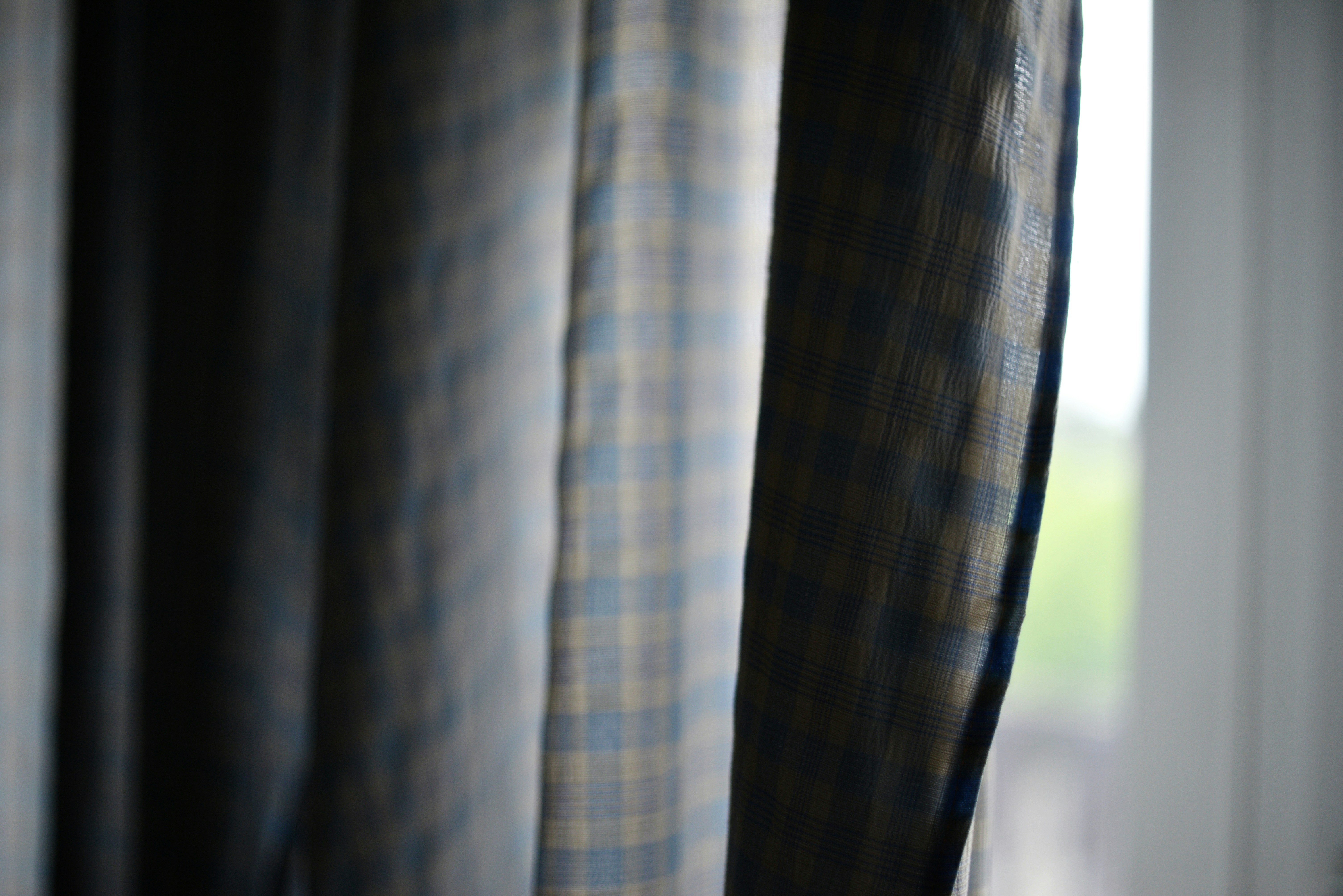 Curtains hang near a window in this image.