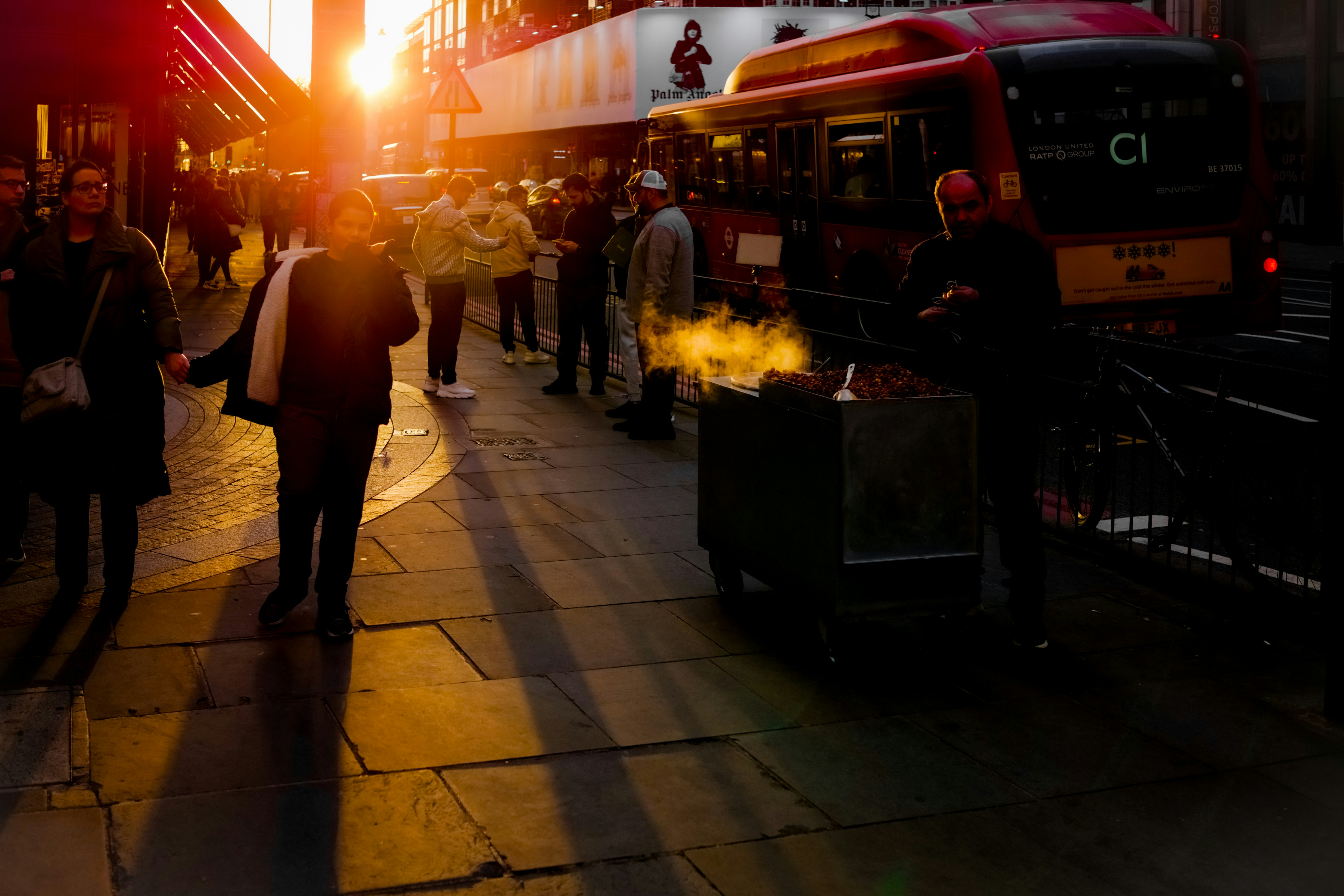 Sunlit Street Vendors at Dusk by the Bus Stop