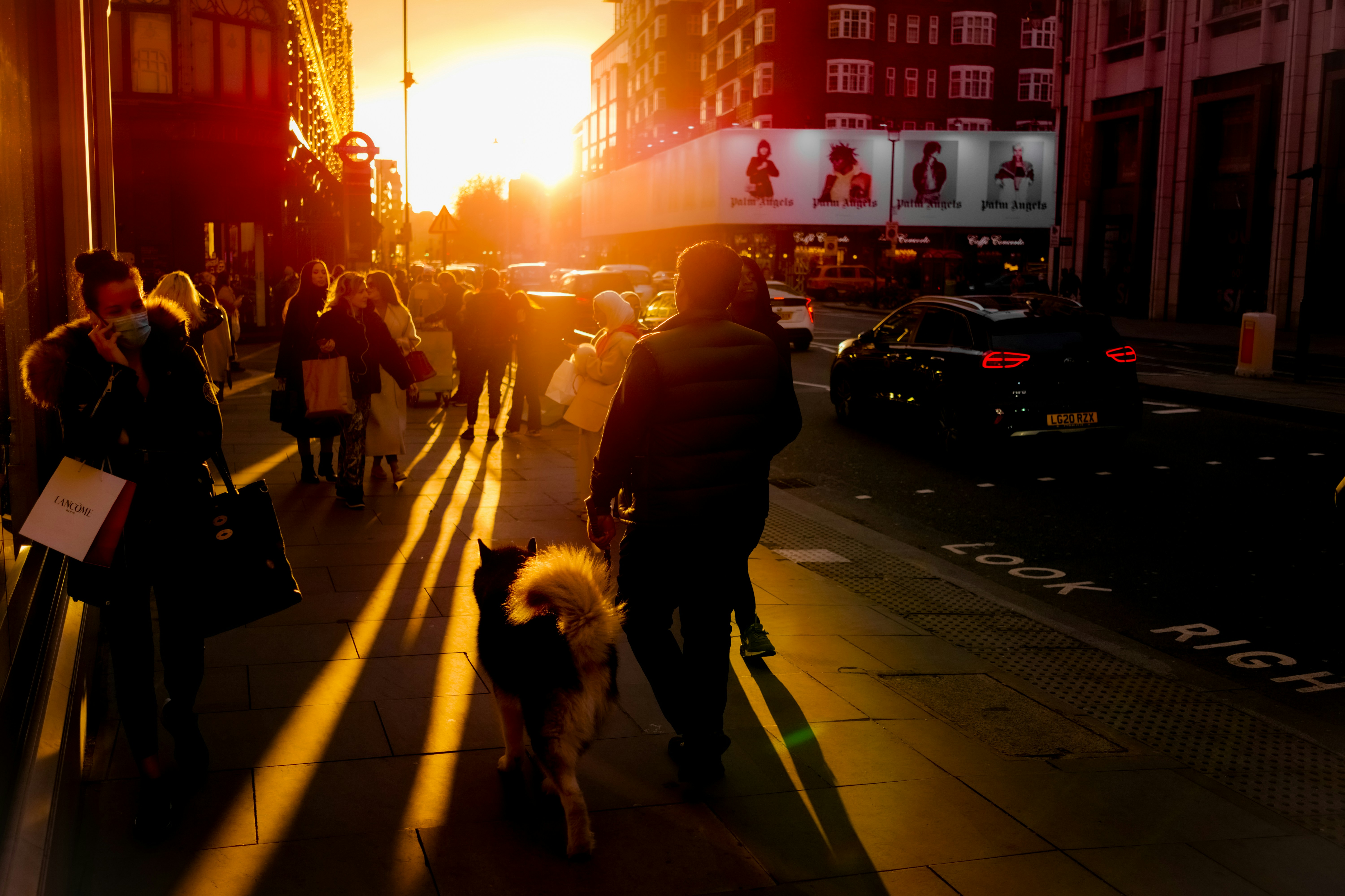 Evening Stride: A Golden Hour Stroll Down a Busy City Street