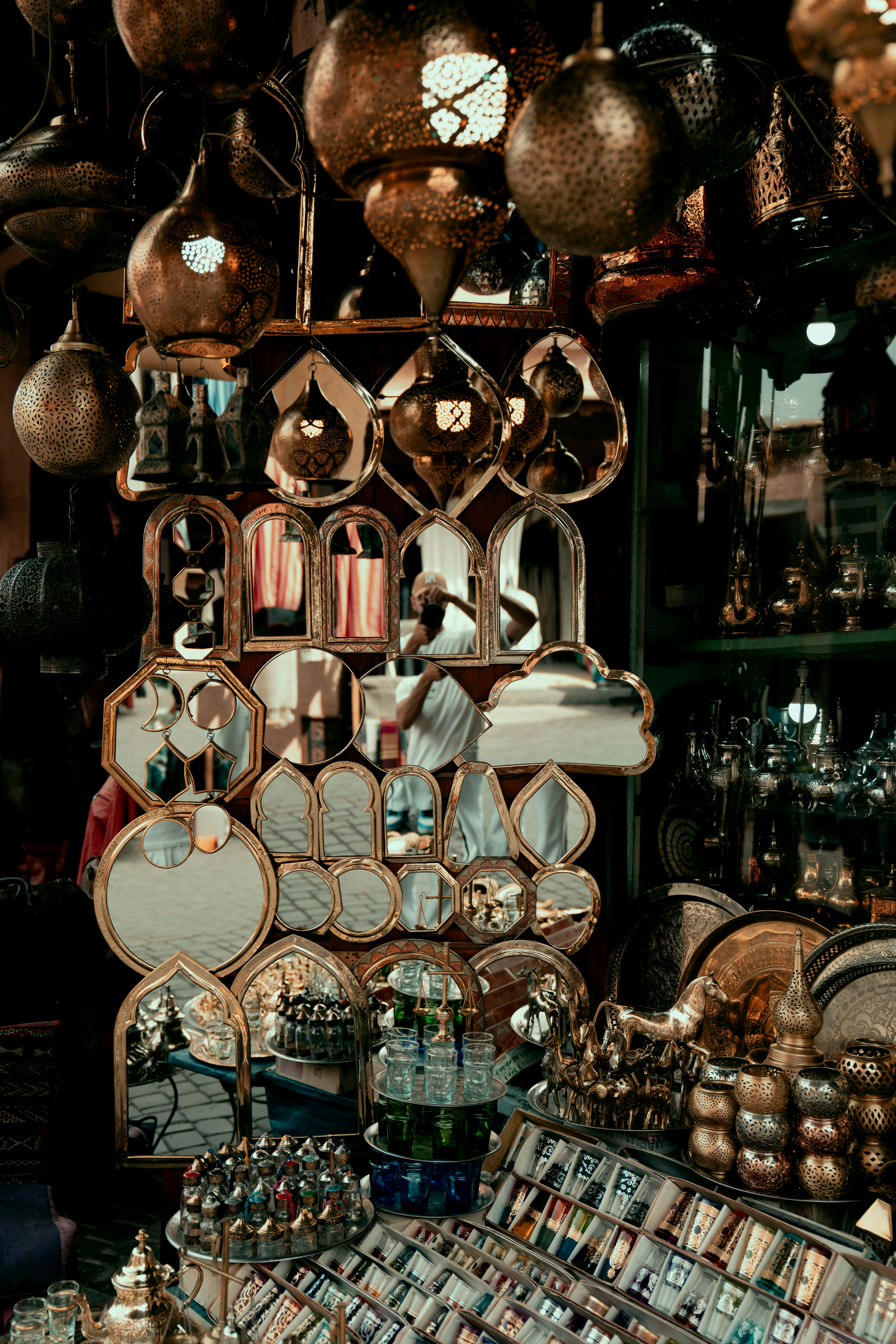 Hand crafts in Morocco | Shop display of mirrors and hanging lanterns.