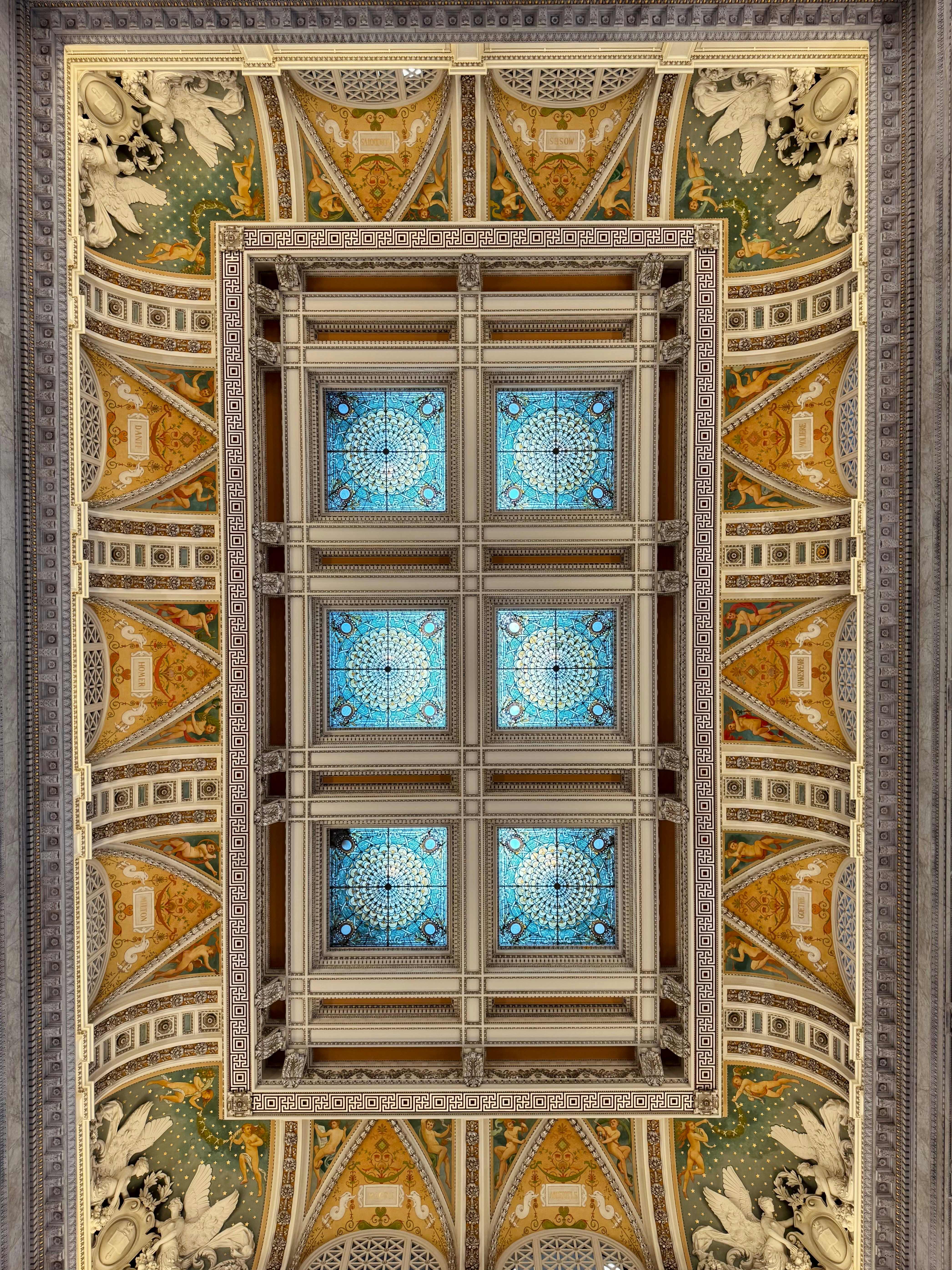 Intricate, ornate ceiling with glass panels.