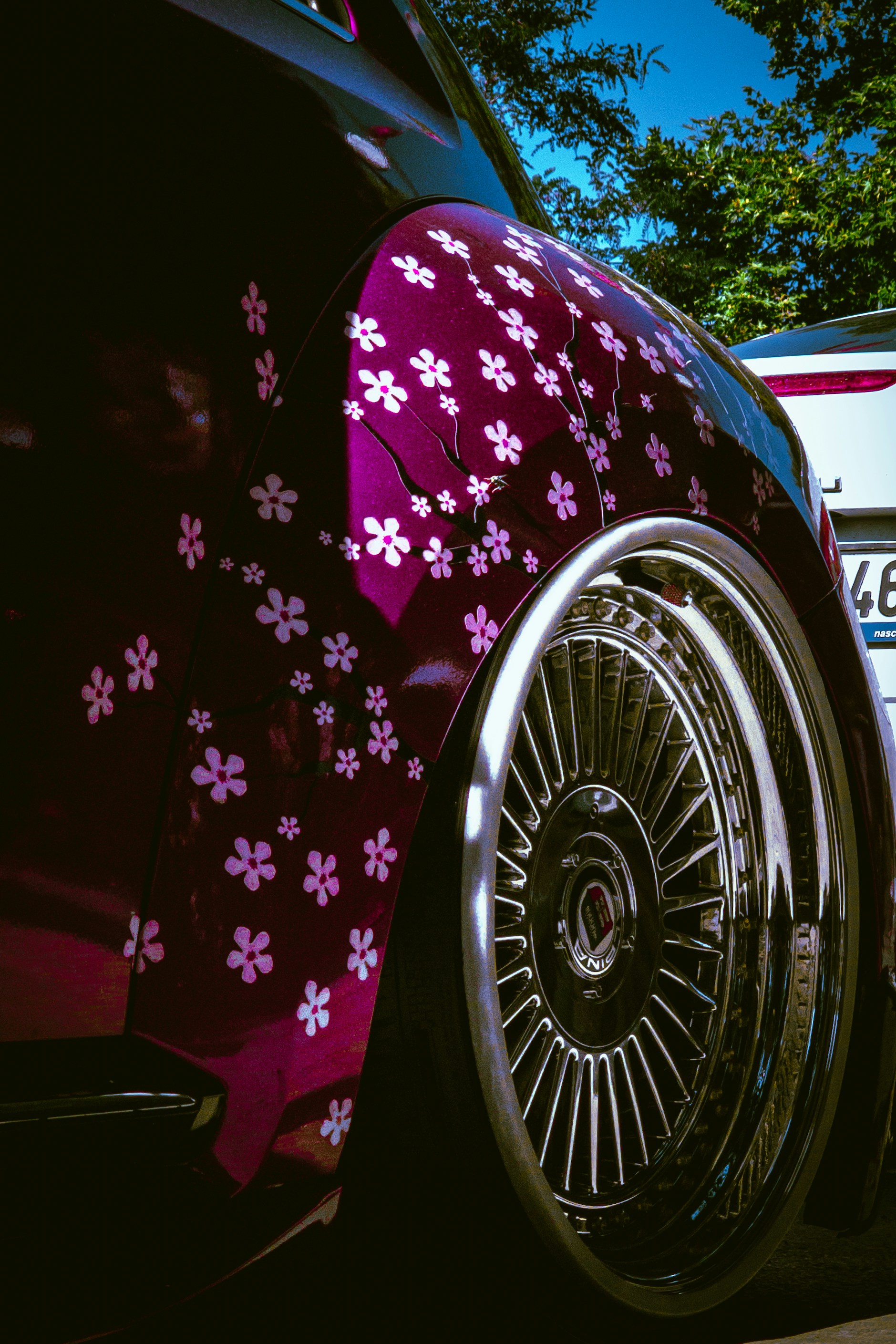 A custom car adorned with cherry blossom details.
