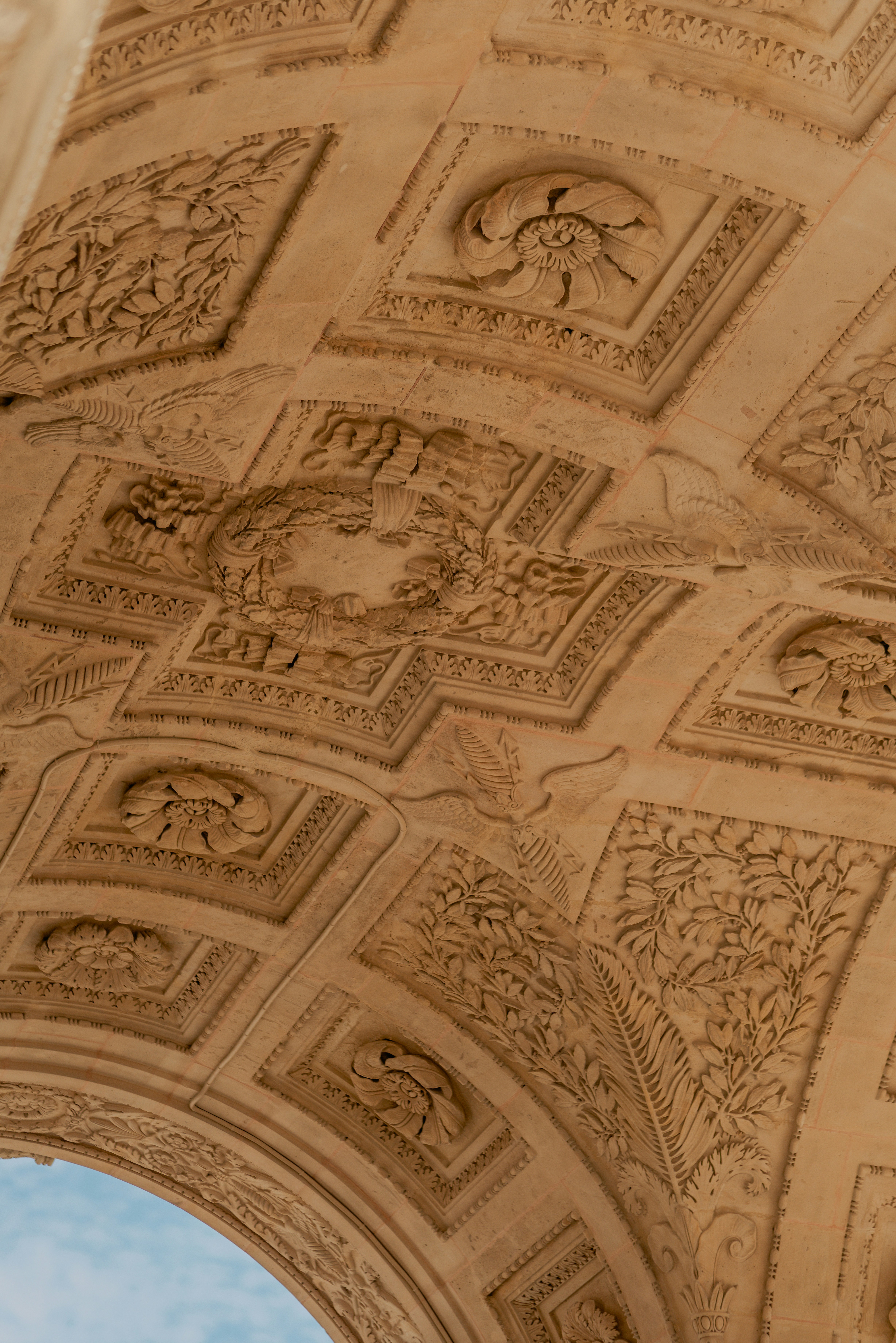 Elaborate ceiling carvings on an archway.
