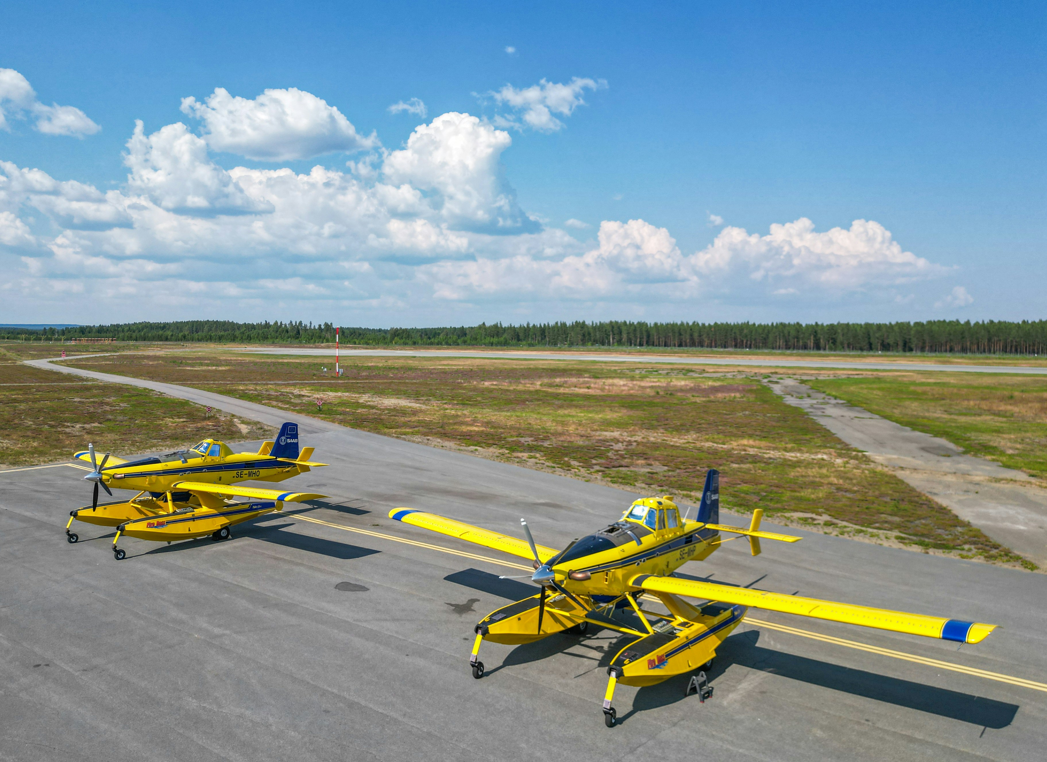 Yellow Wings on the Tarmac: Aerial Guardians Await