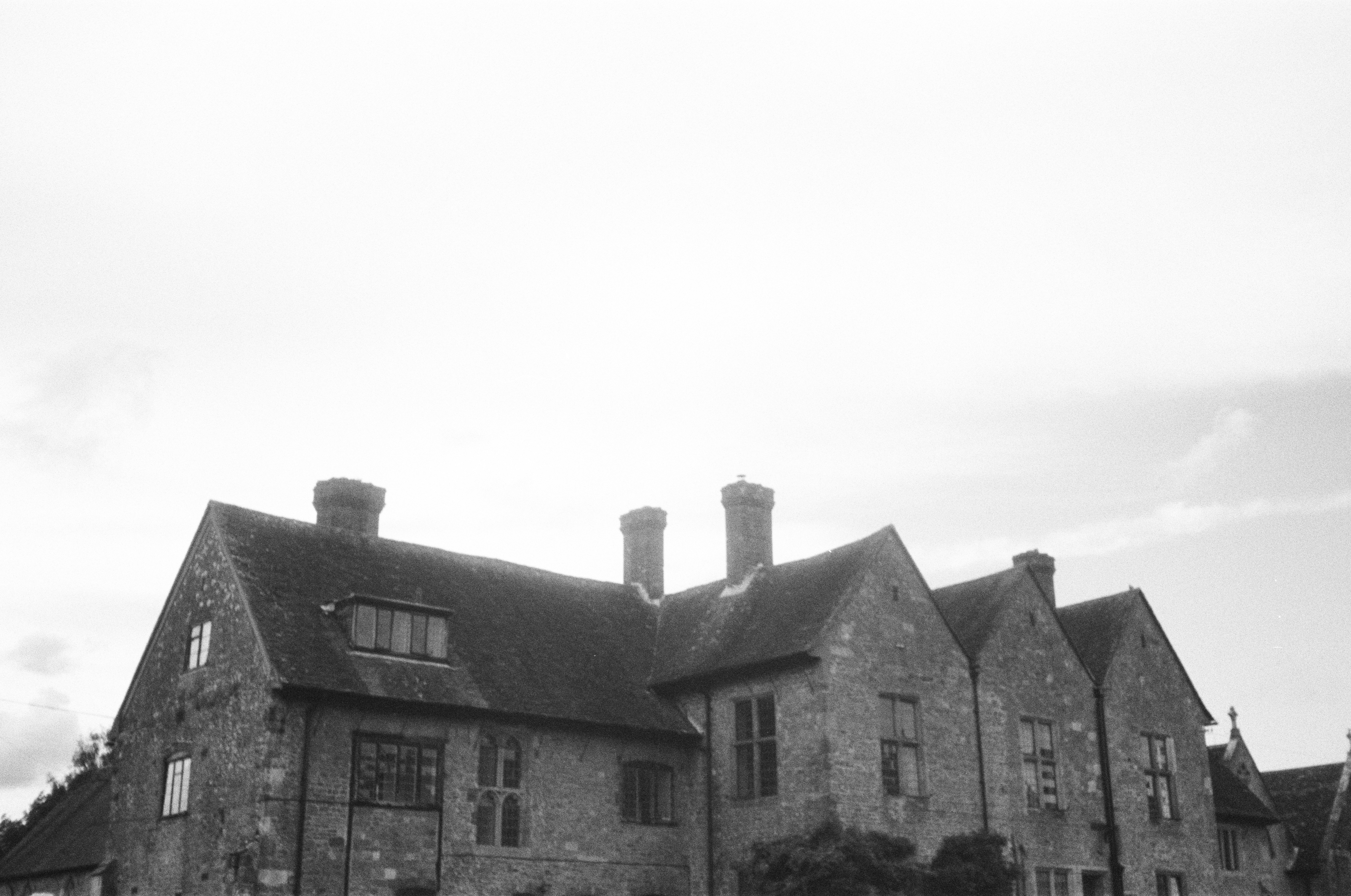 Old brick house with a light sky.