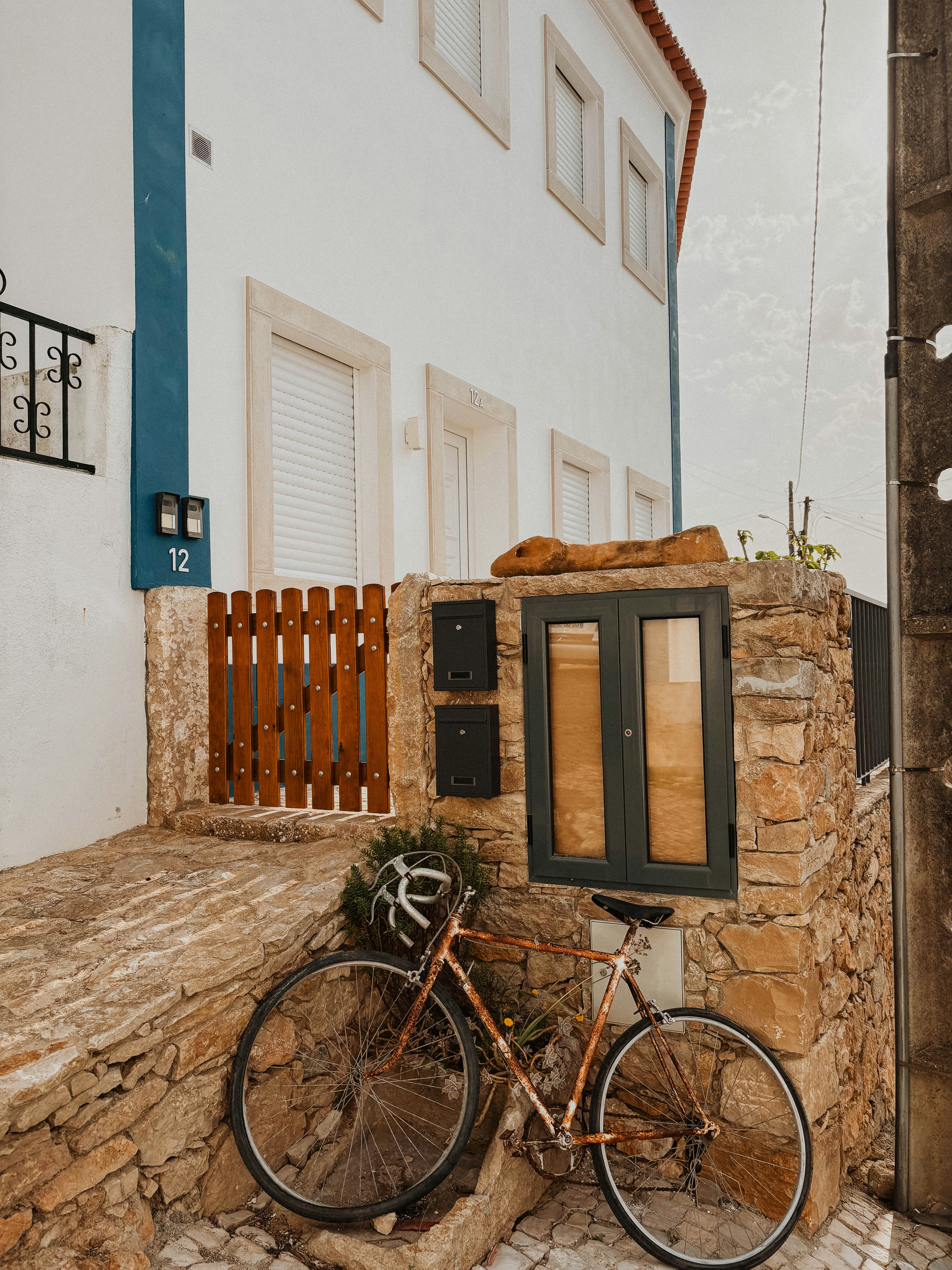 Bicycle Leaning Against a Sun-Warmed Stone Wall in a Quiet Portuguese Street