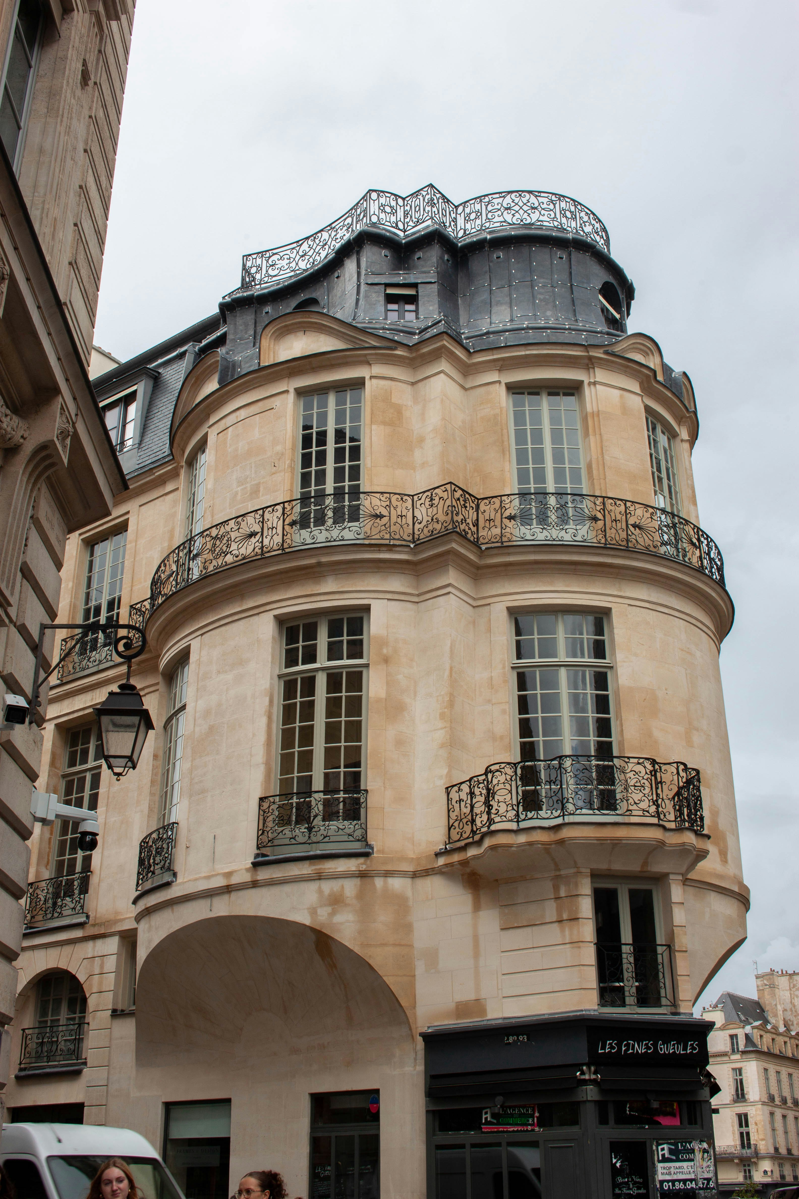 Beautiful, ornate building with rounded edges and balconies.