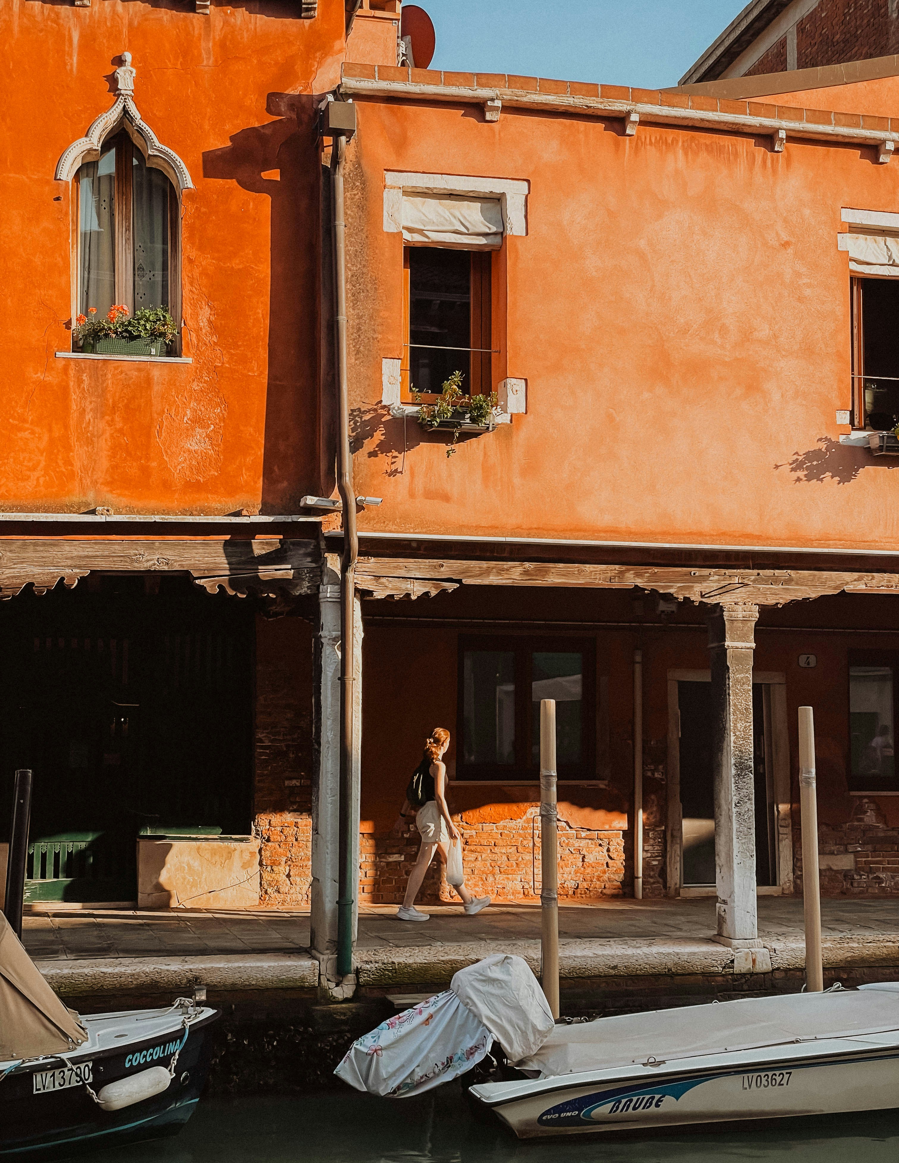 Orange Facade, Silent Canal: A Quiet Moment by the Water’s Edge