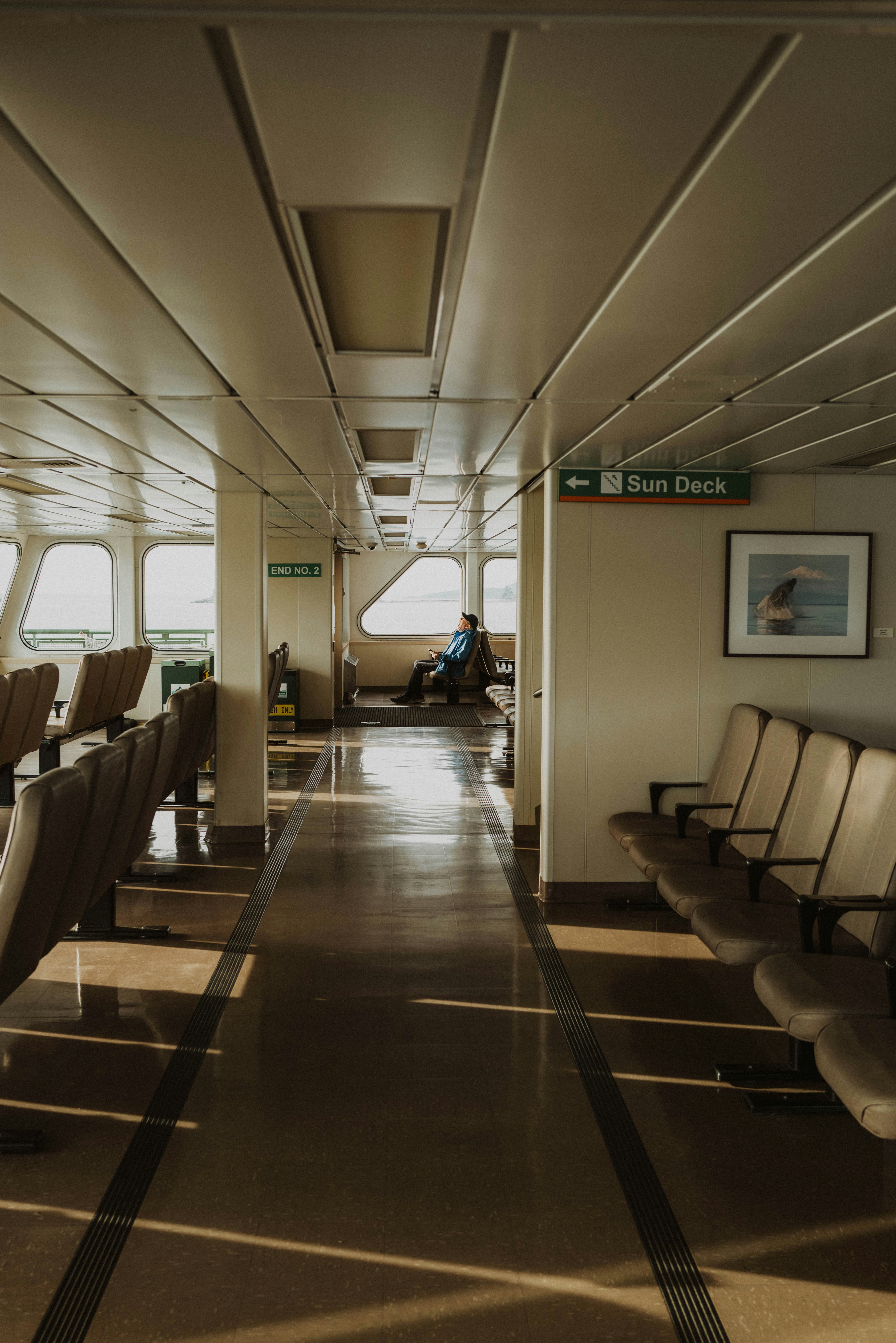 A ferry's interior with a sun deck sign. photo – Free Image on Unsplash