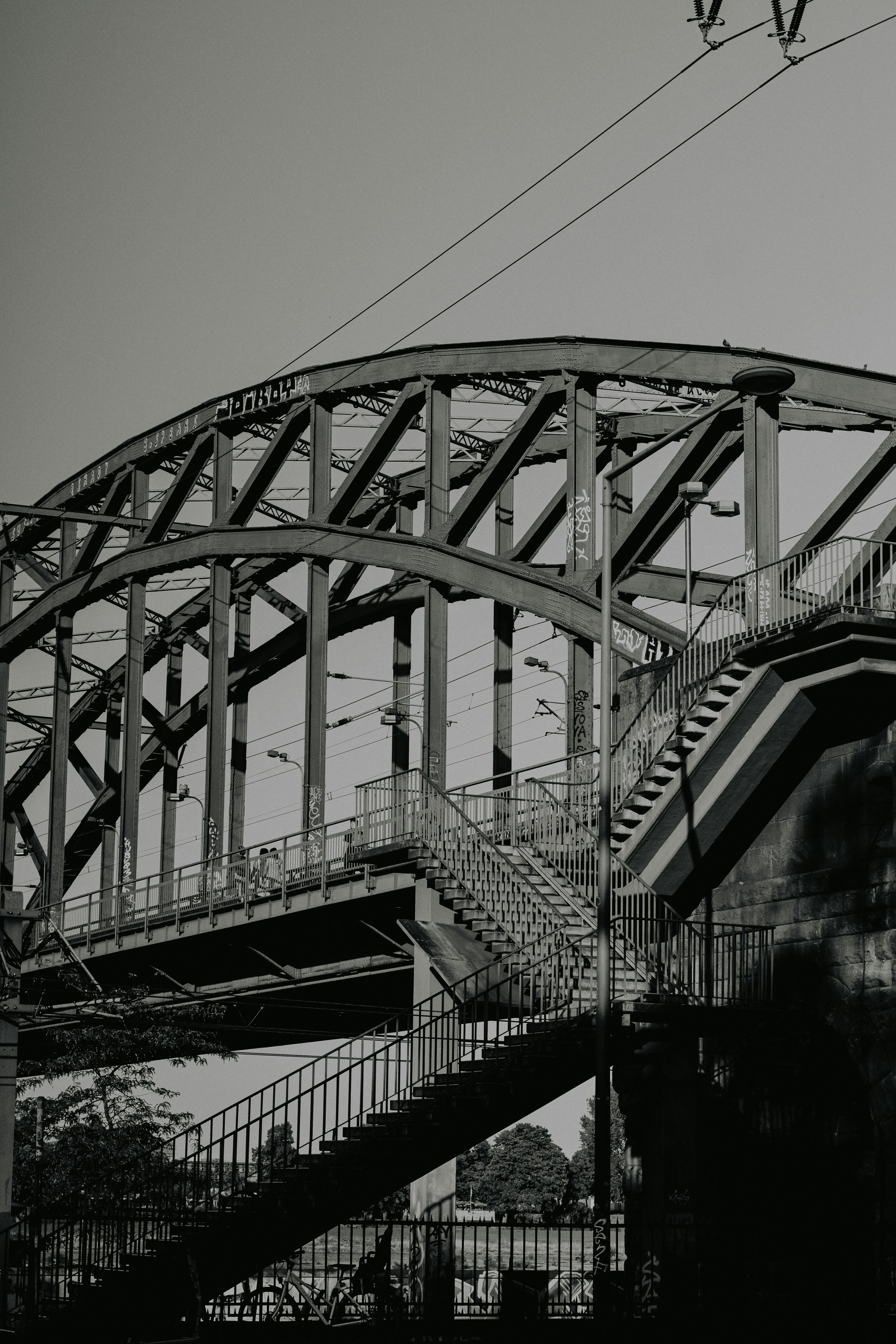 A black and white bridge with stairs.