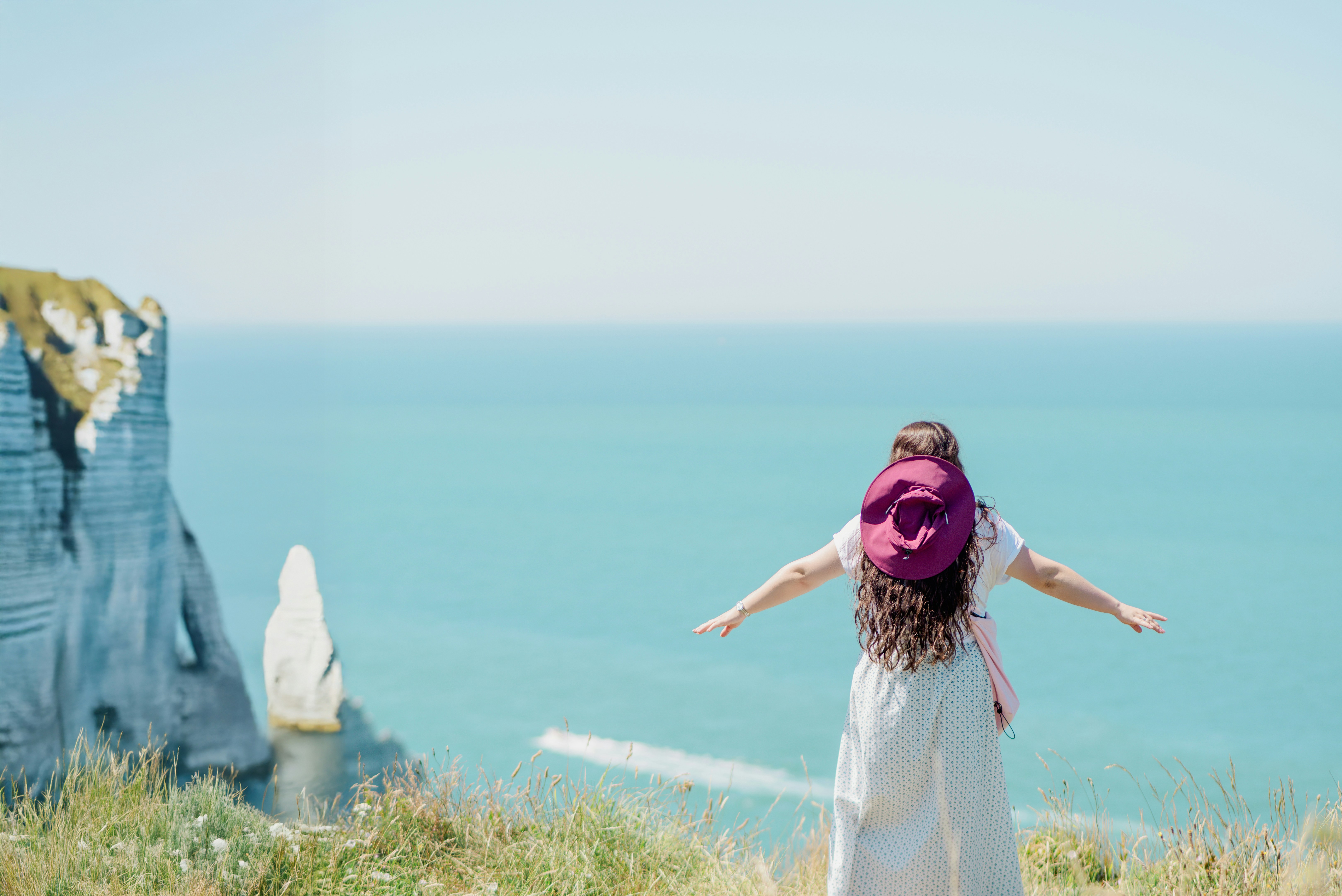 Woman enjoys scenic view with open arms.