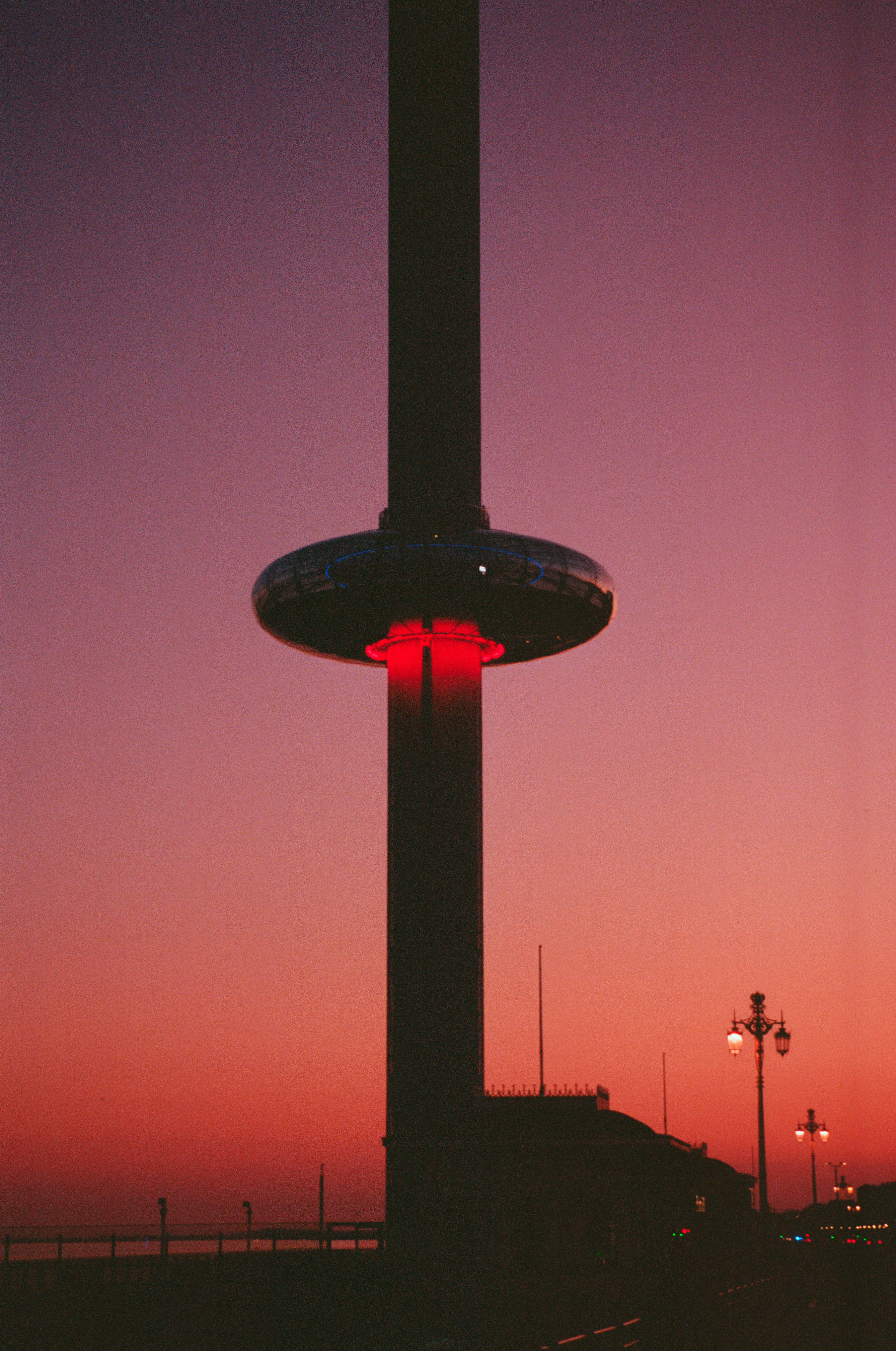 Captured at dusk, the silhouette of the iconic tower against a vibrant sunset sky evokes a sense of tranquility and wonder.