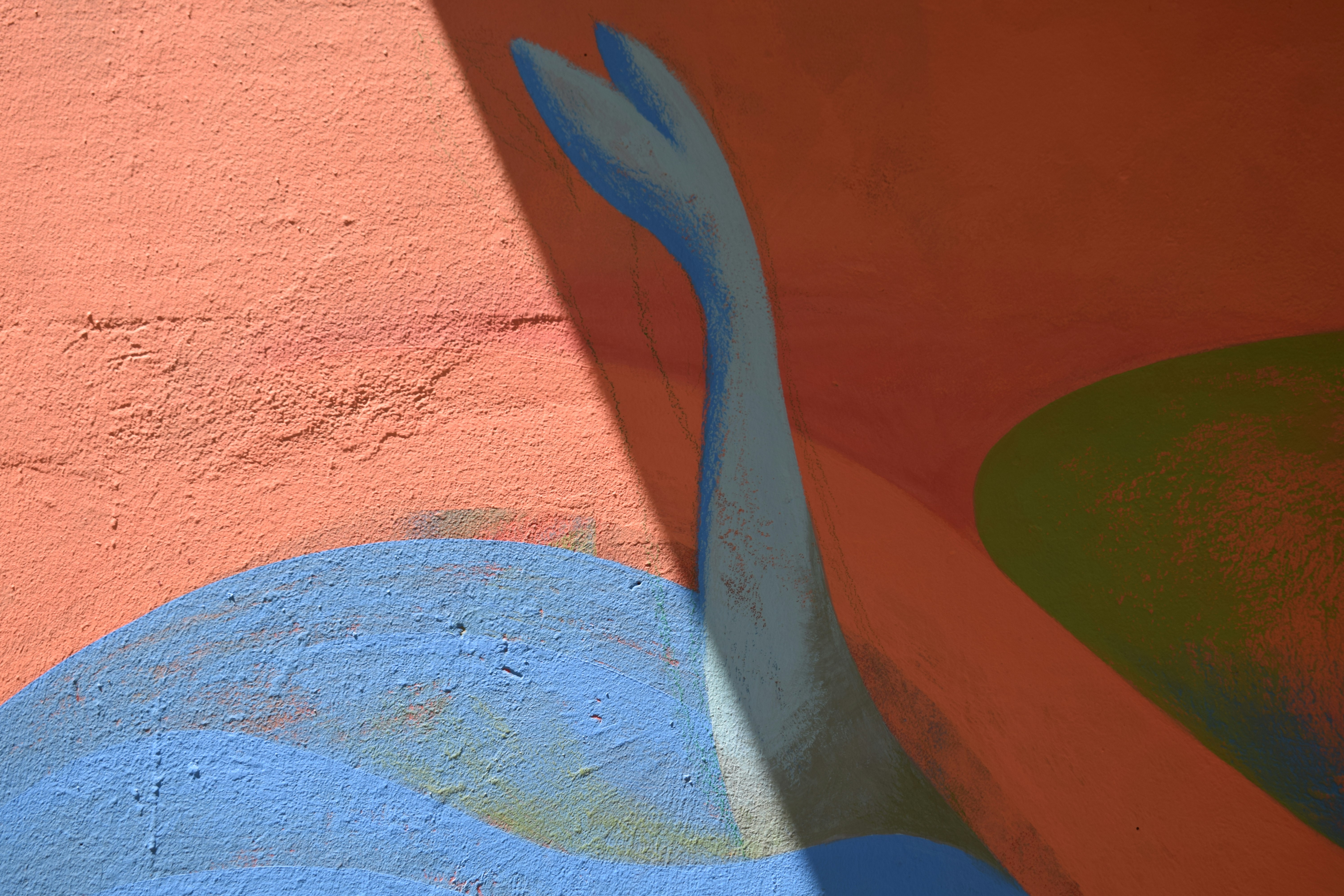 Abstract, colorful mural with shadows and shapes.