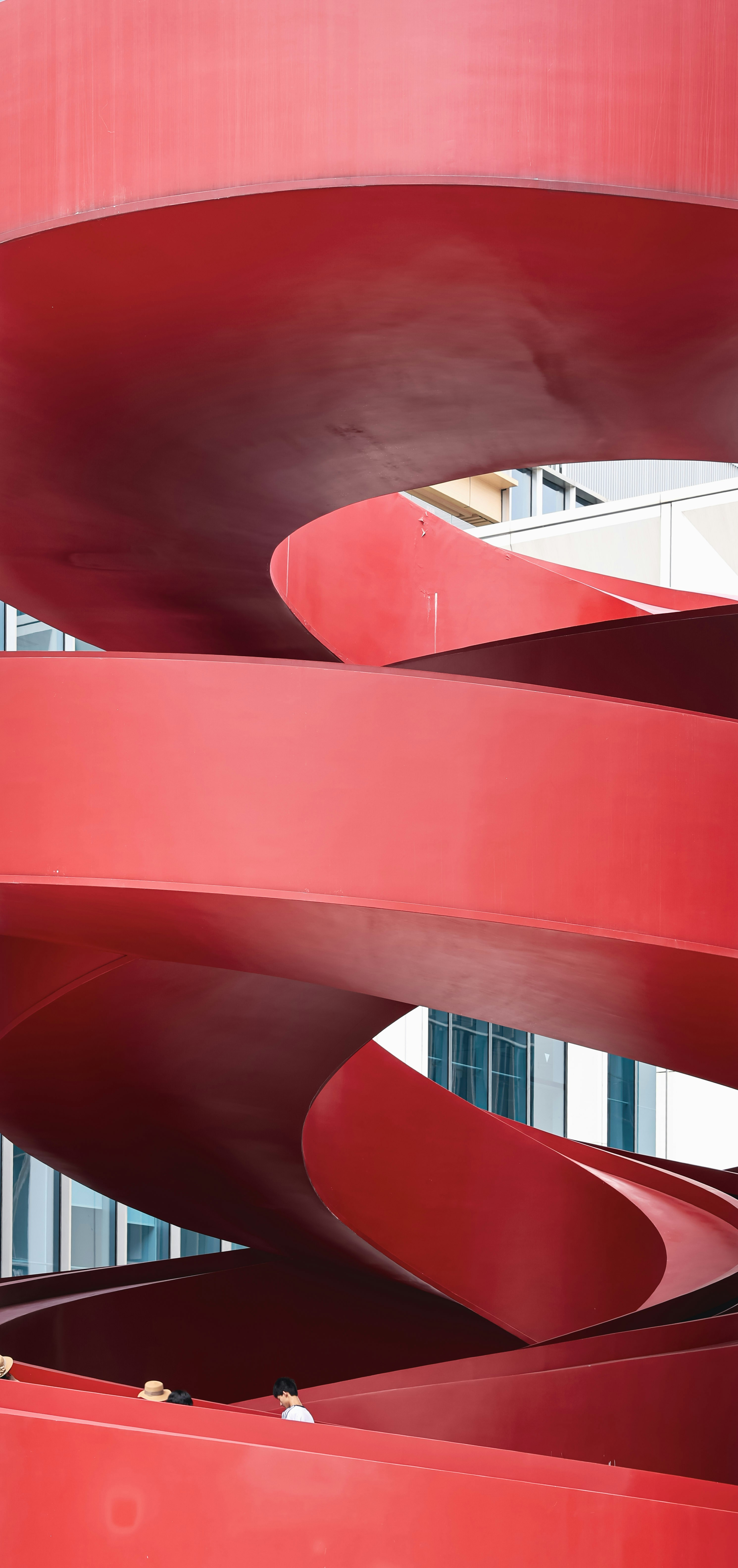 A red, swirling architectural structure.