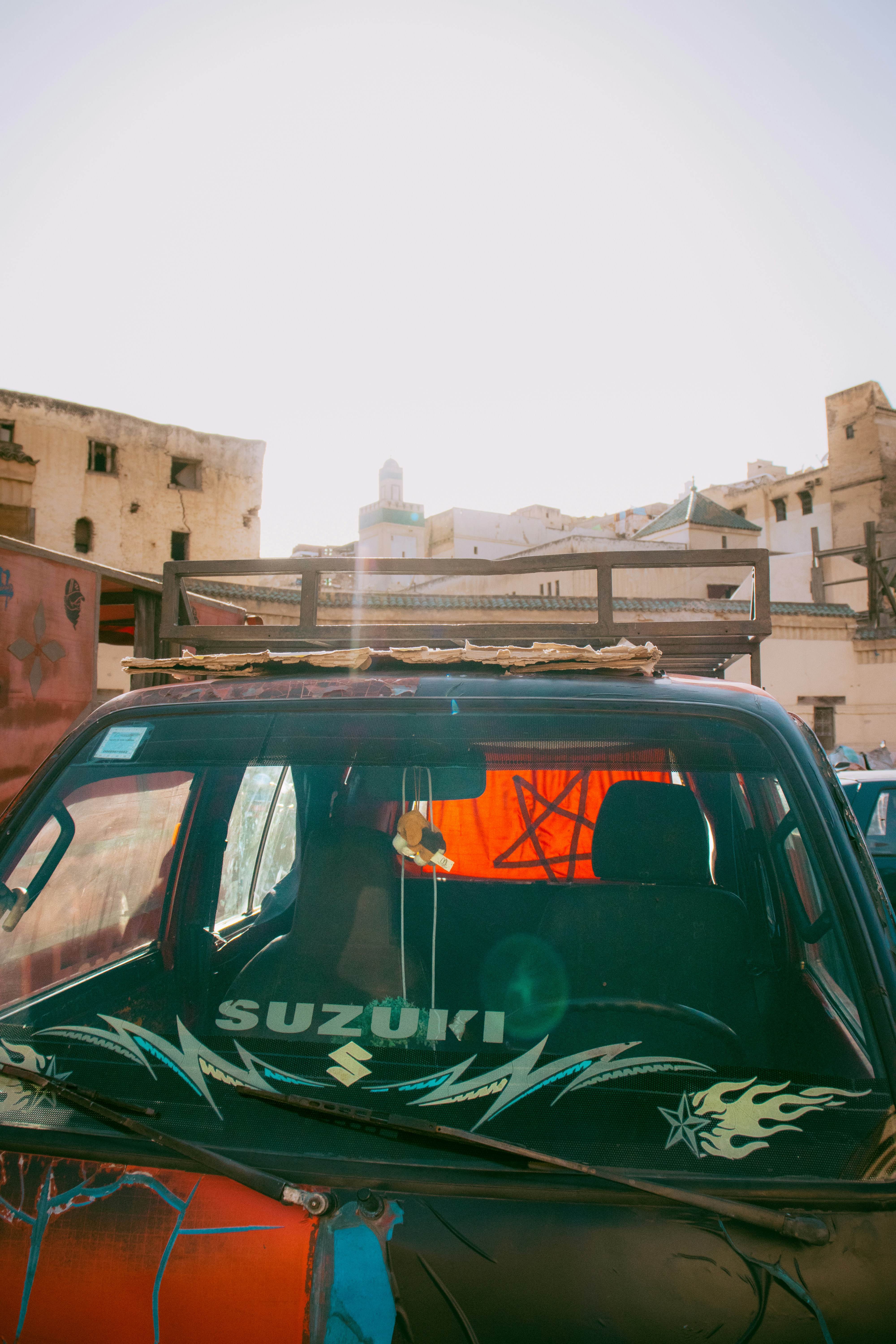 Front-and-Craze: A Weathered Suzuki Under a Blazing Sky