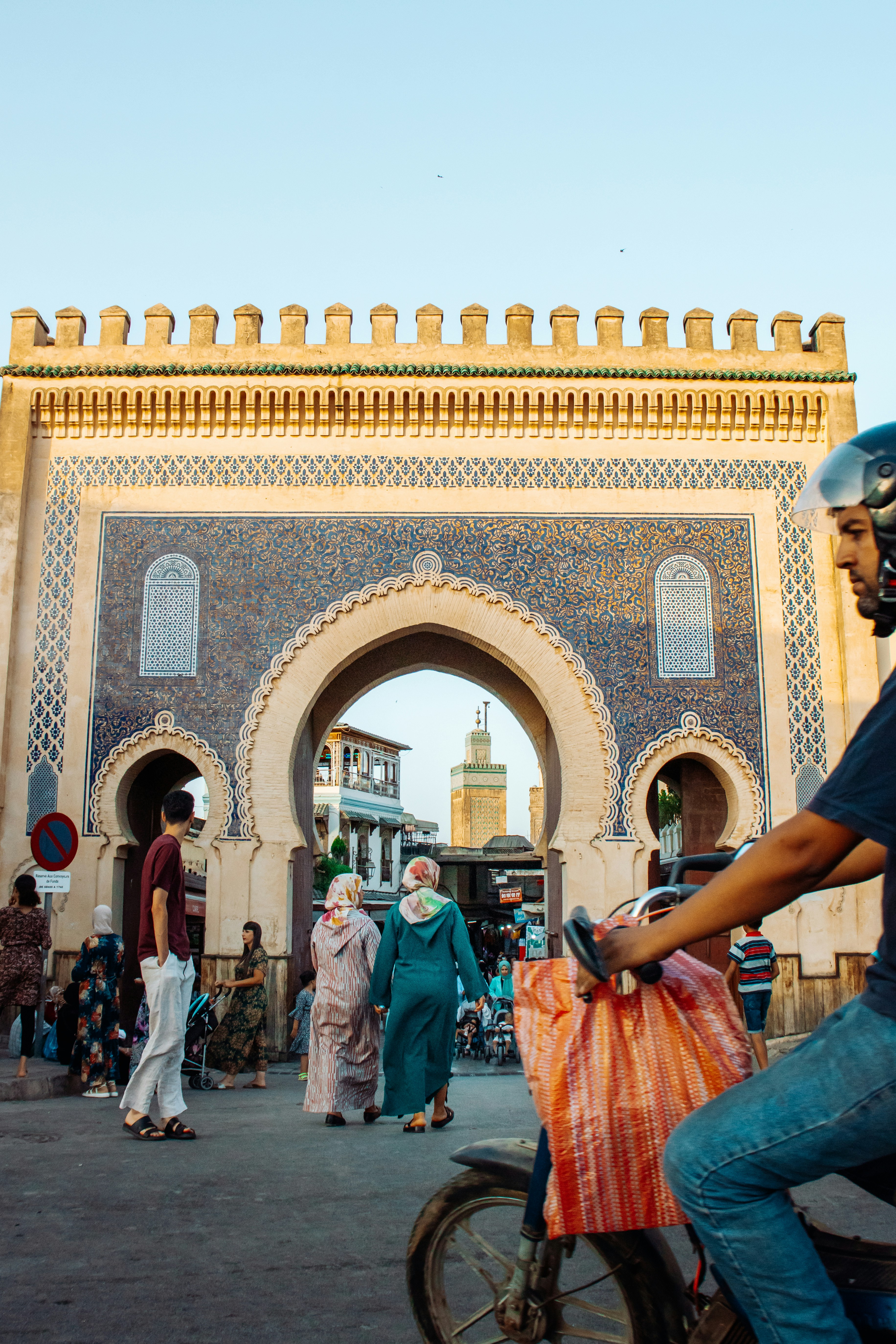 Gateway Mosaic: Arch, People, and Street in Motion
