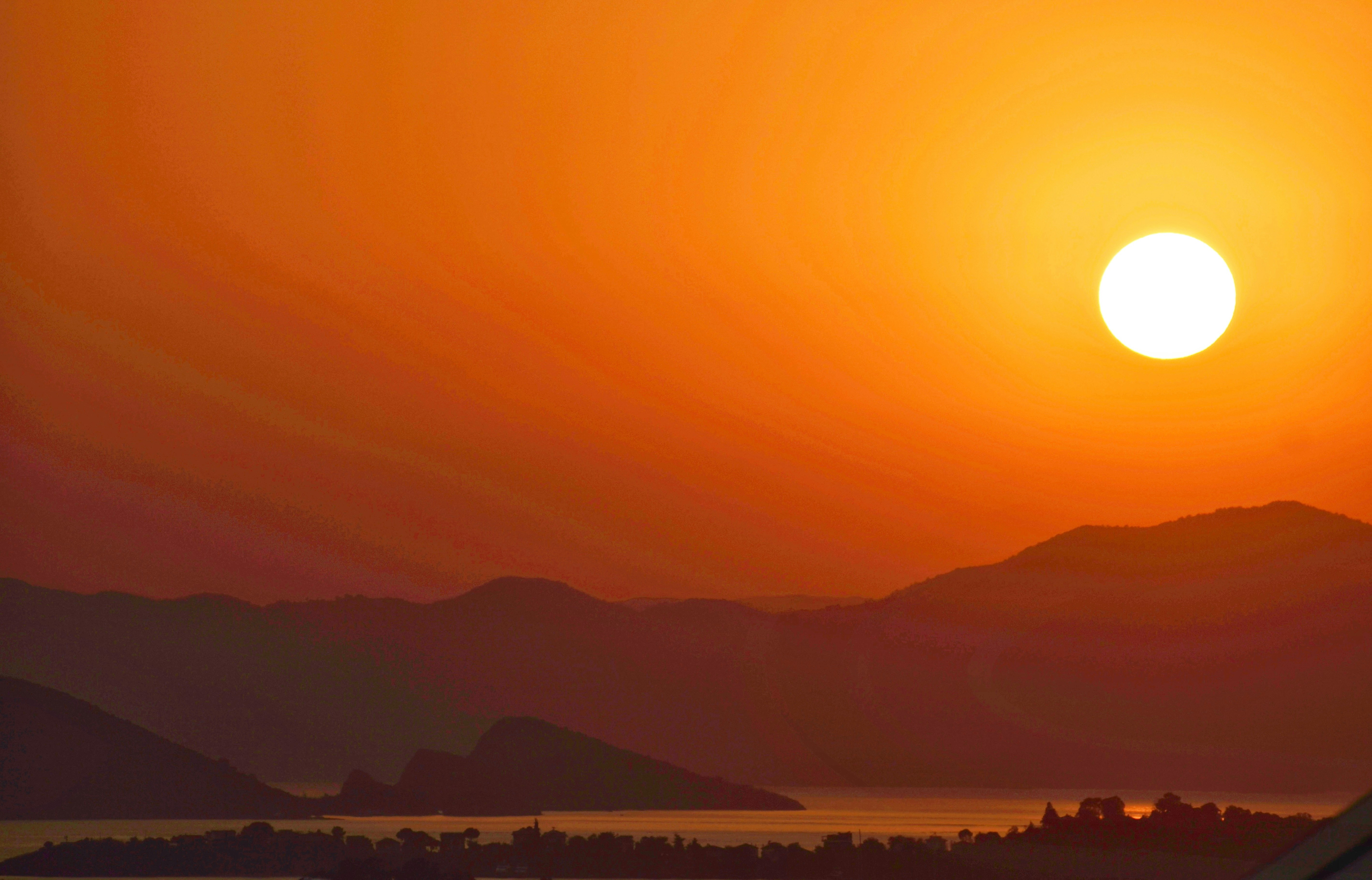 Crimson Horizon: The Sun Over Quiet Valleys