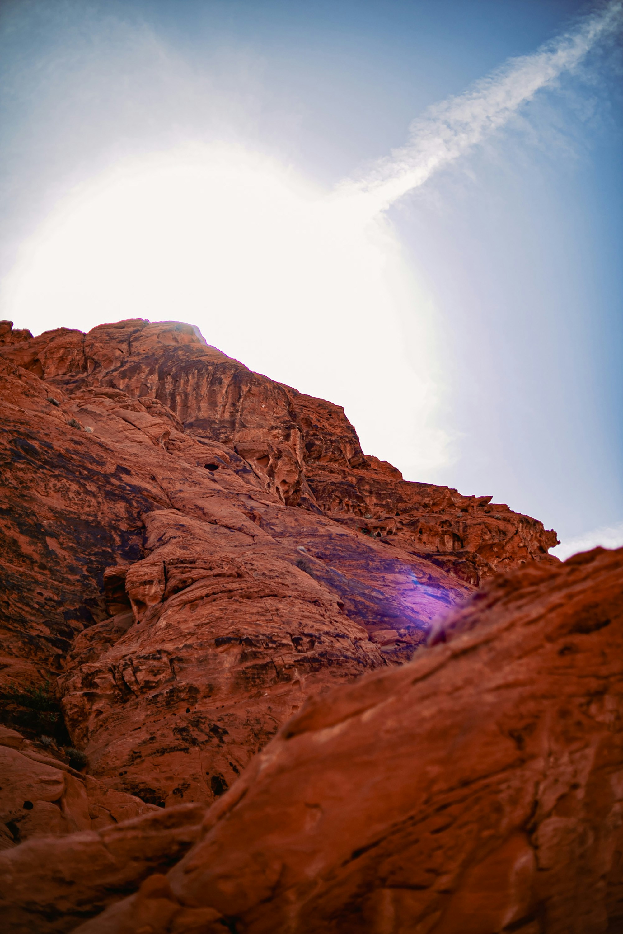 Red rocks are illuminated by the sun.