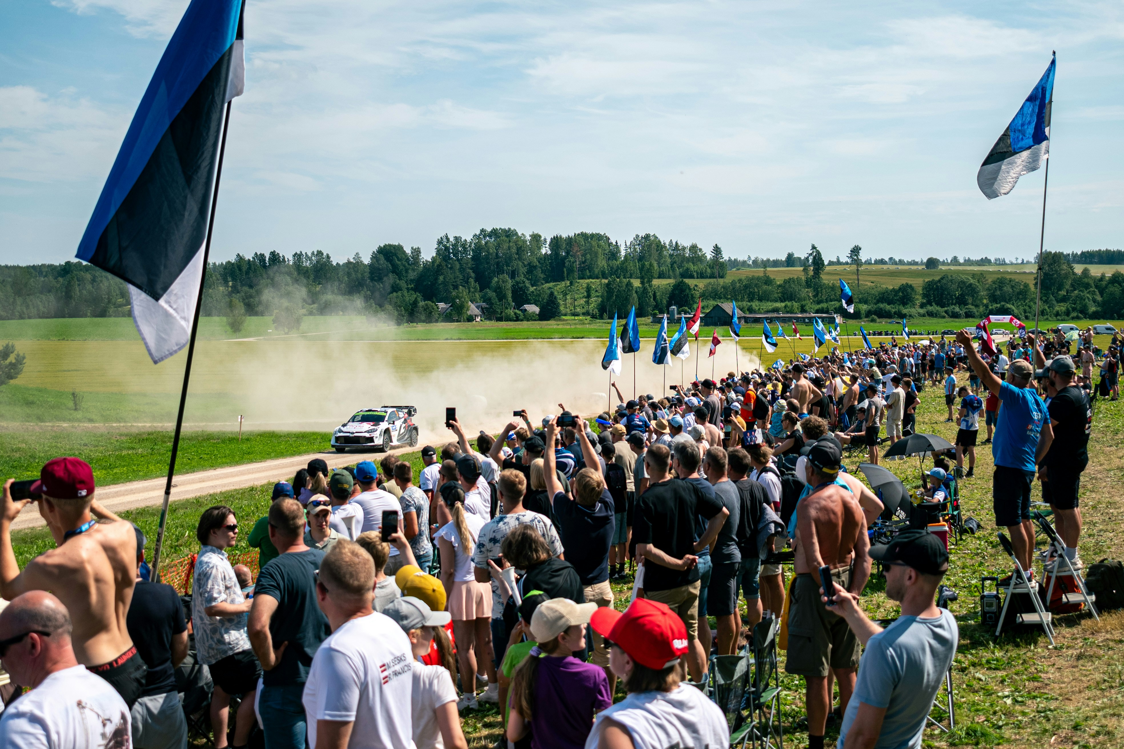 Rally car speeds past excited spectators. photo – Free Car Image on ...