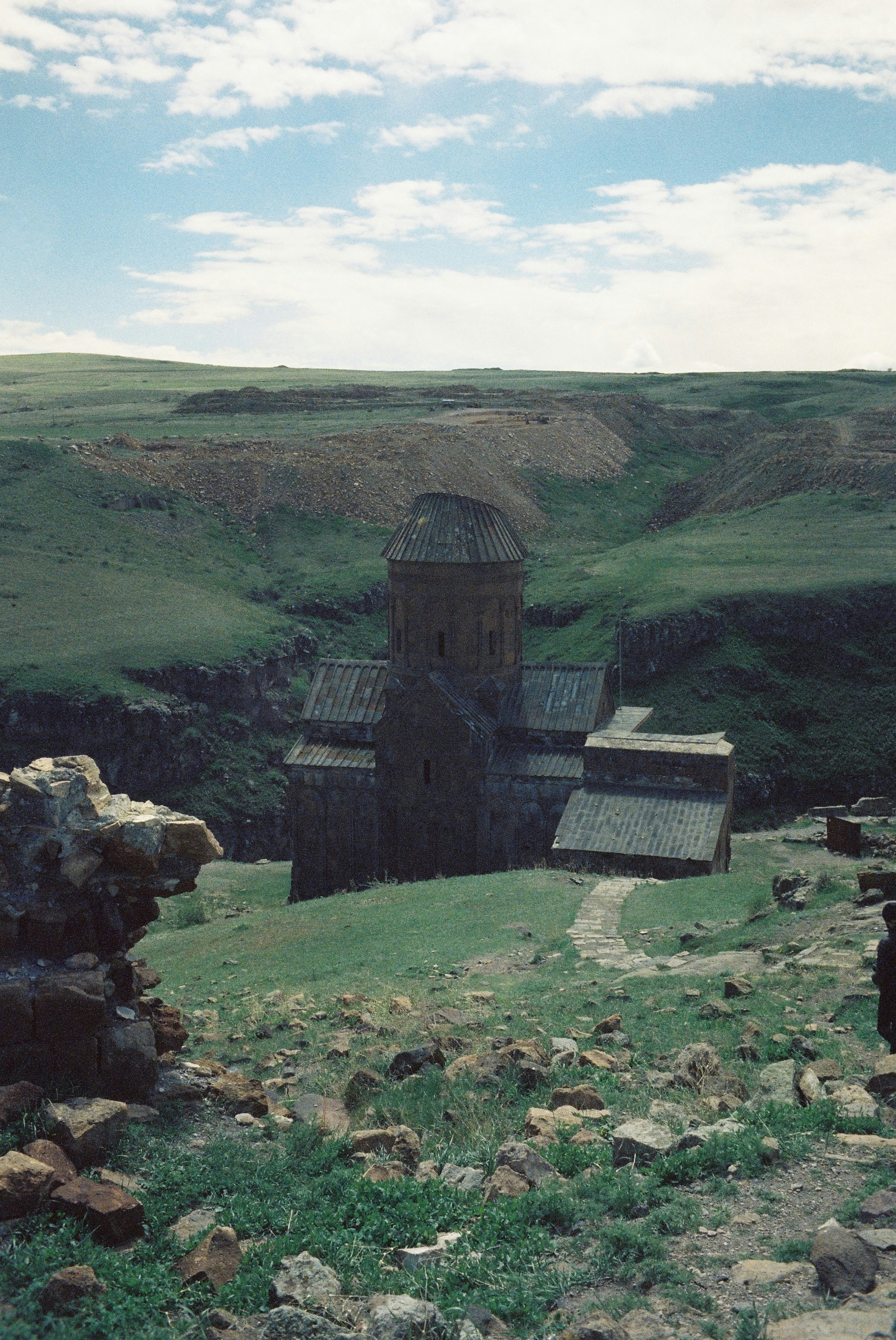 Ancient church stands amidst a beautiful landscape.