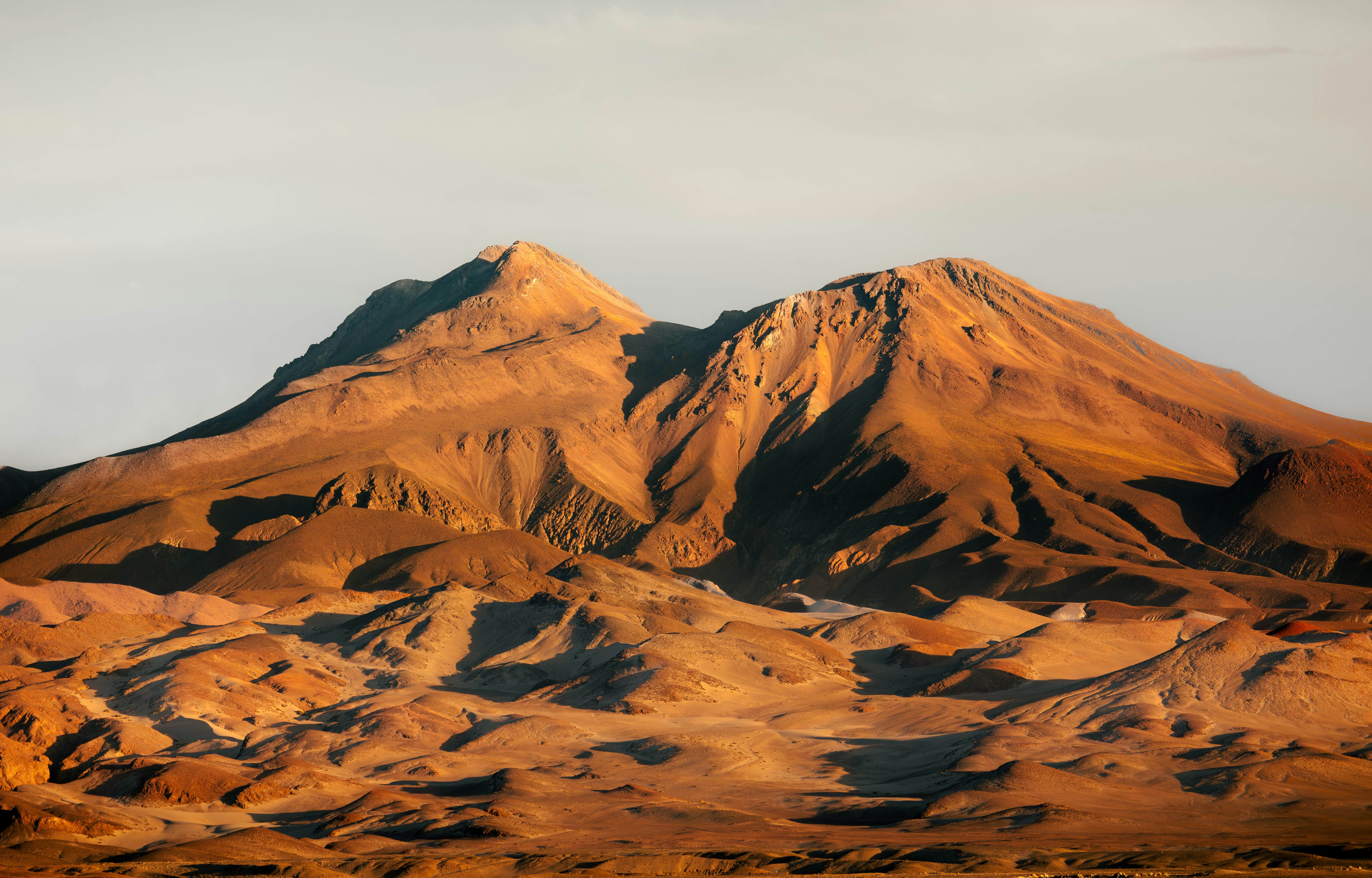 "Volcanic" | Mountains bathed in golden sunlight are pictured.