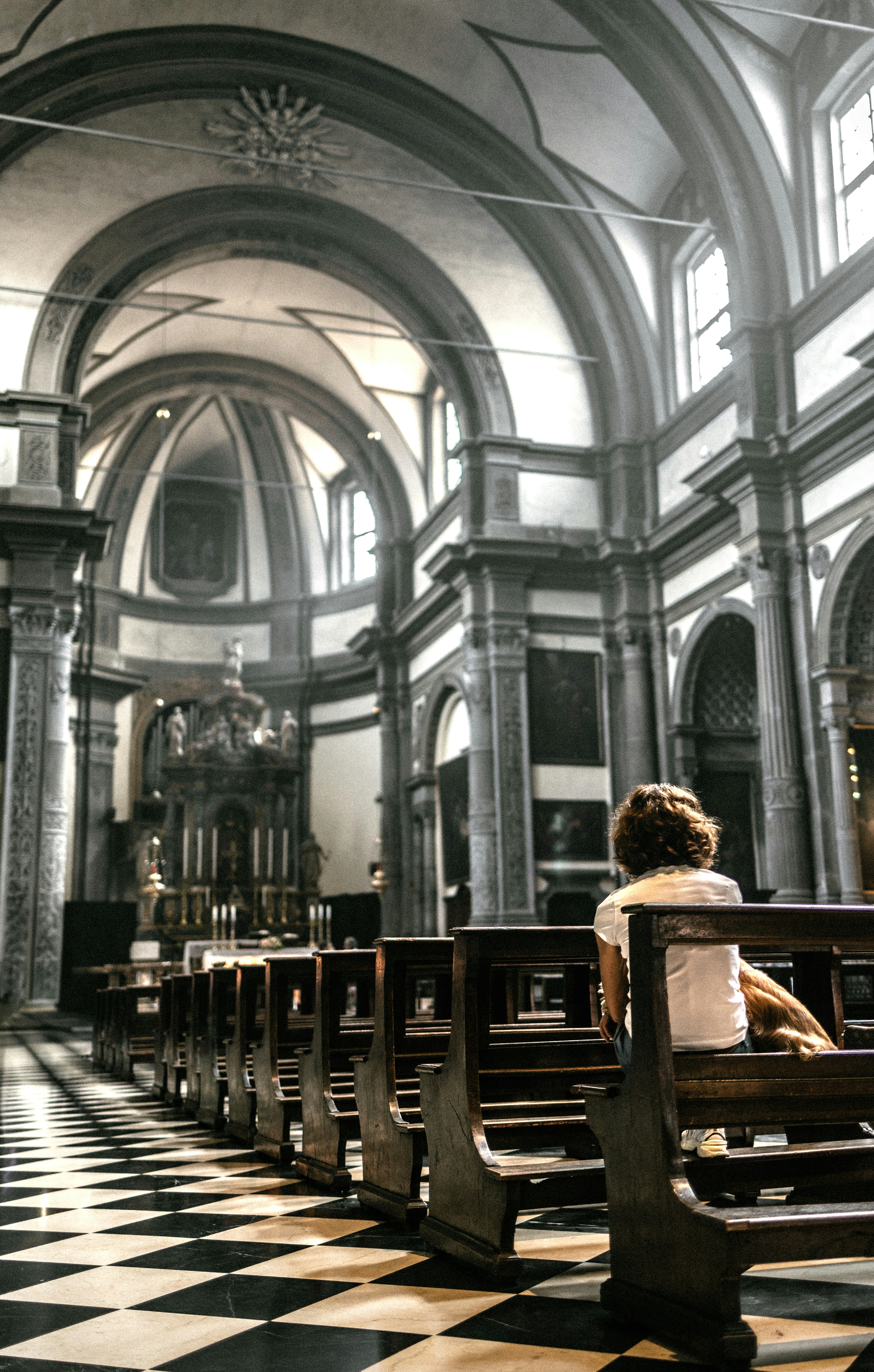 "Prayer" | Woman sits in a church pew.