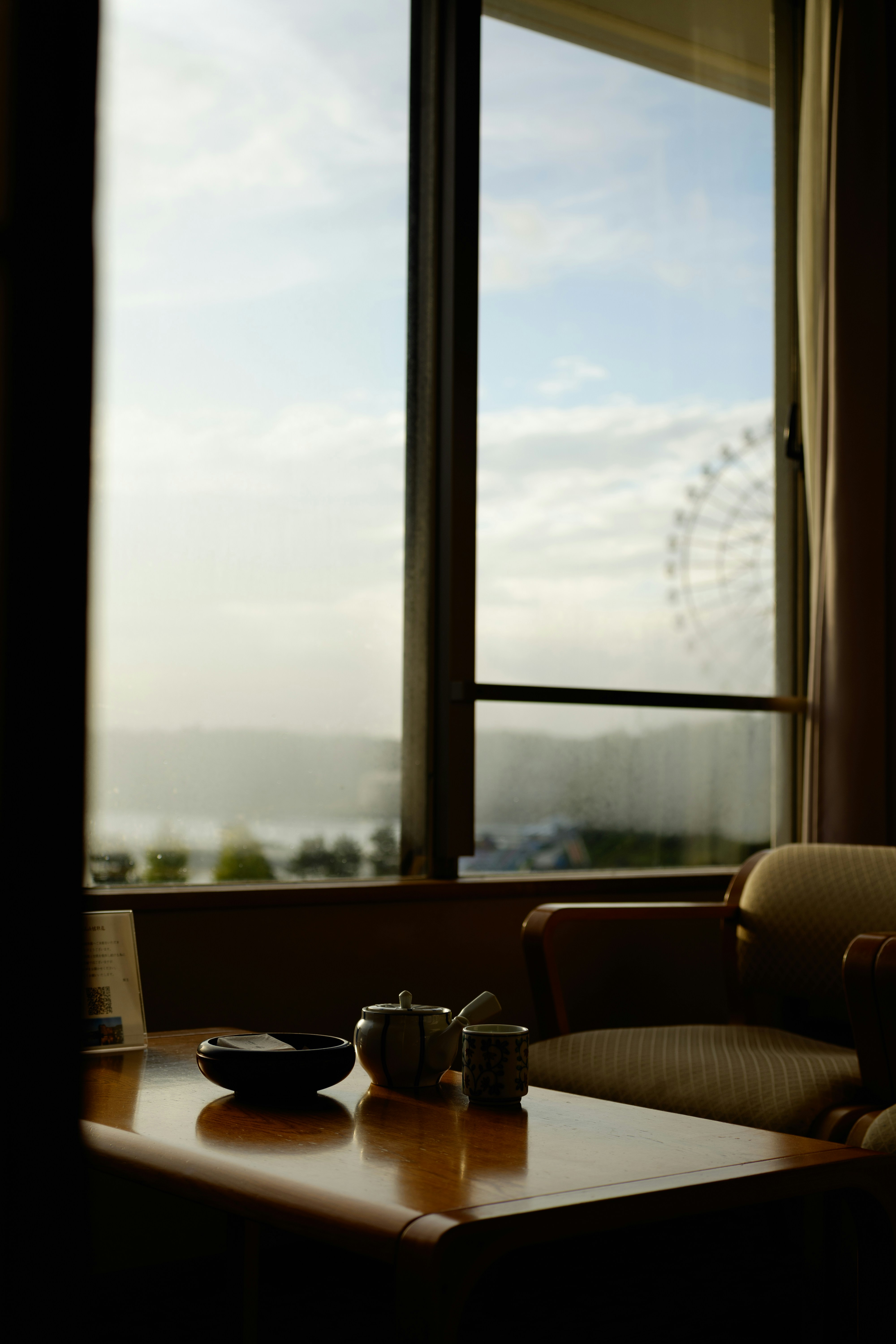 Tea set on a table with a scenic view.