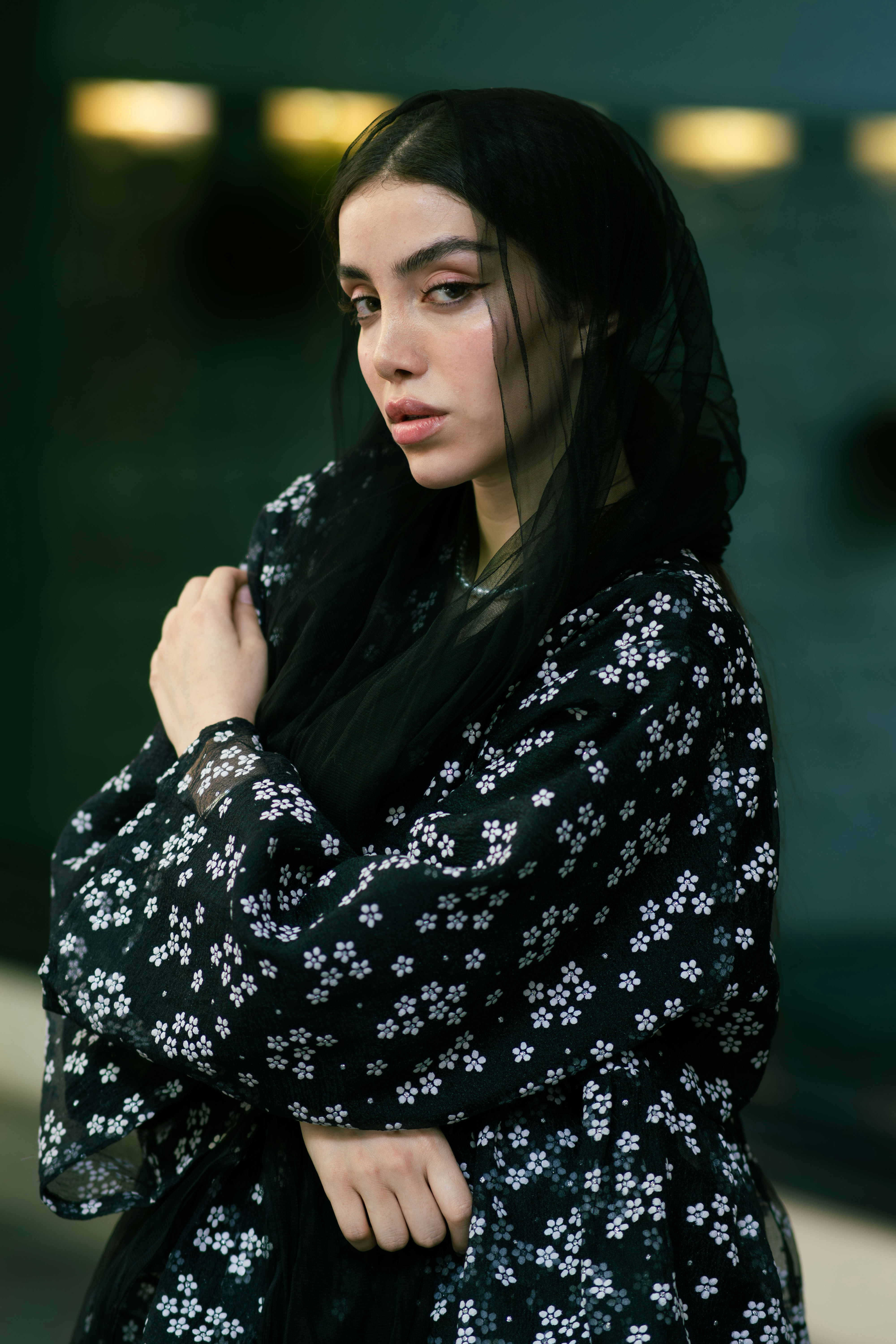 Photograph by Amin Naderloei | A woman poses in floral clothing.