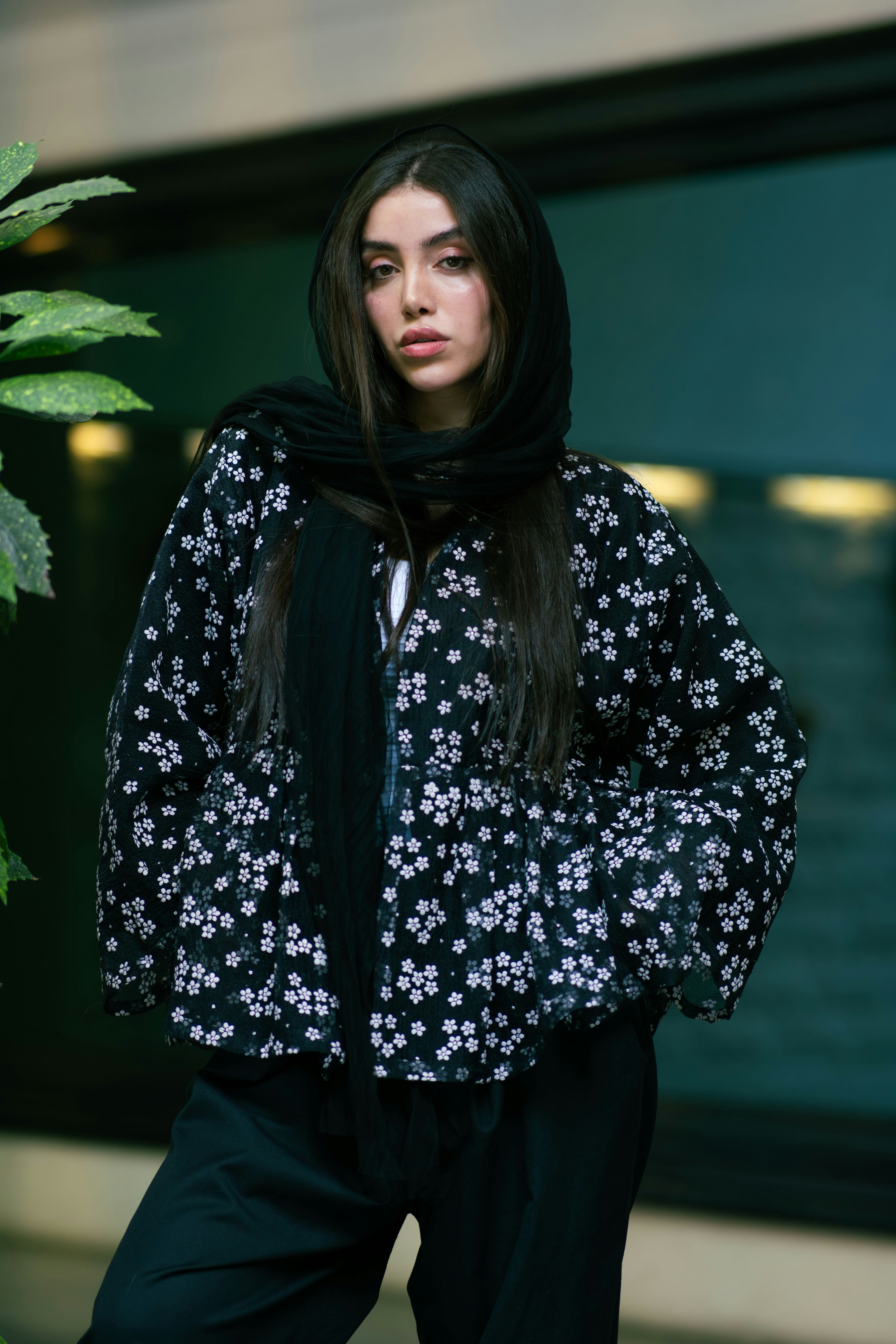 Photograph by Amin Naderloei | A young woman poses in floral attire.