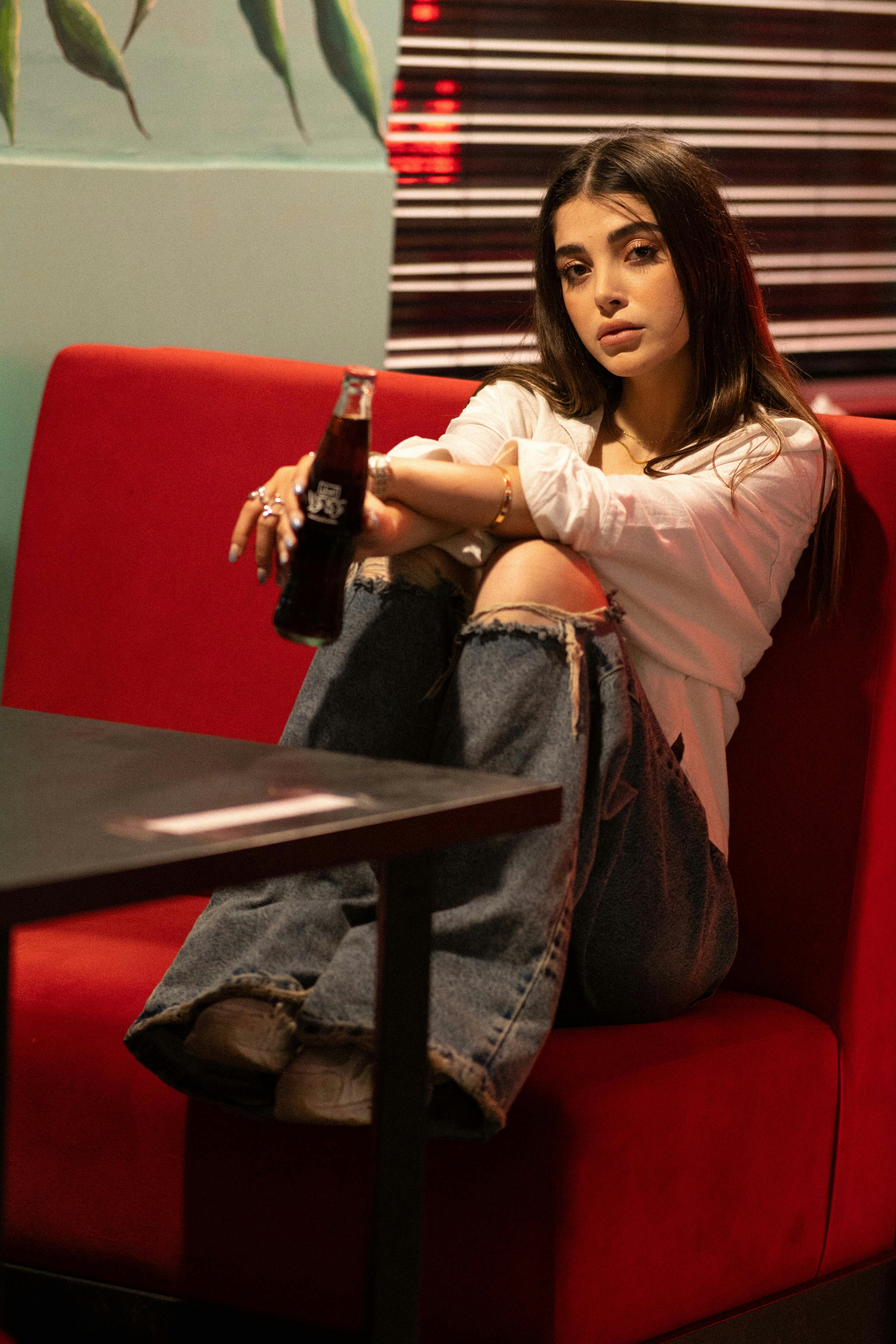 Red Booth Reverie: Quiet Confidence in Neon Glow