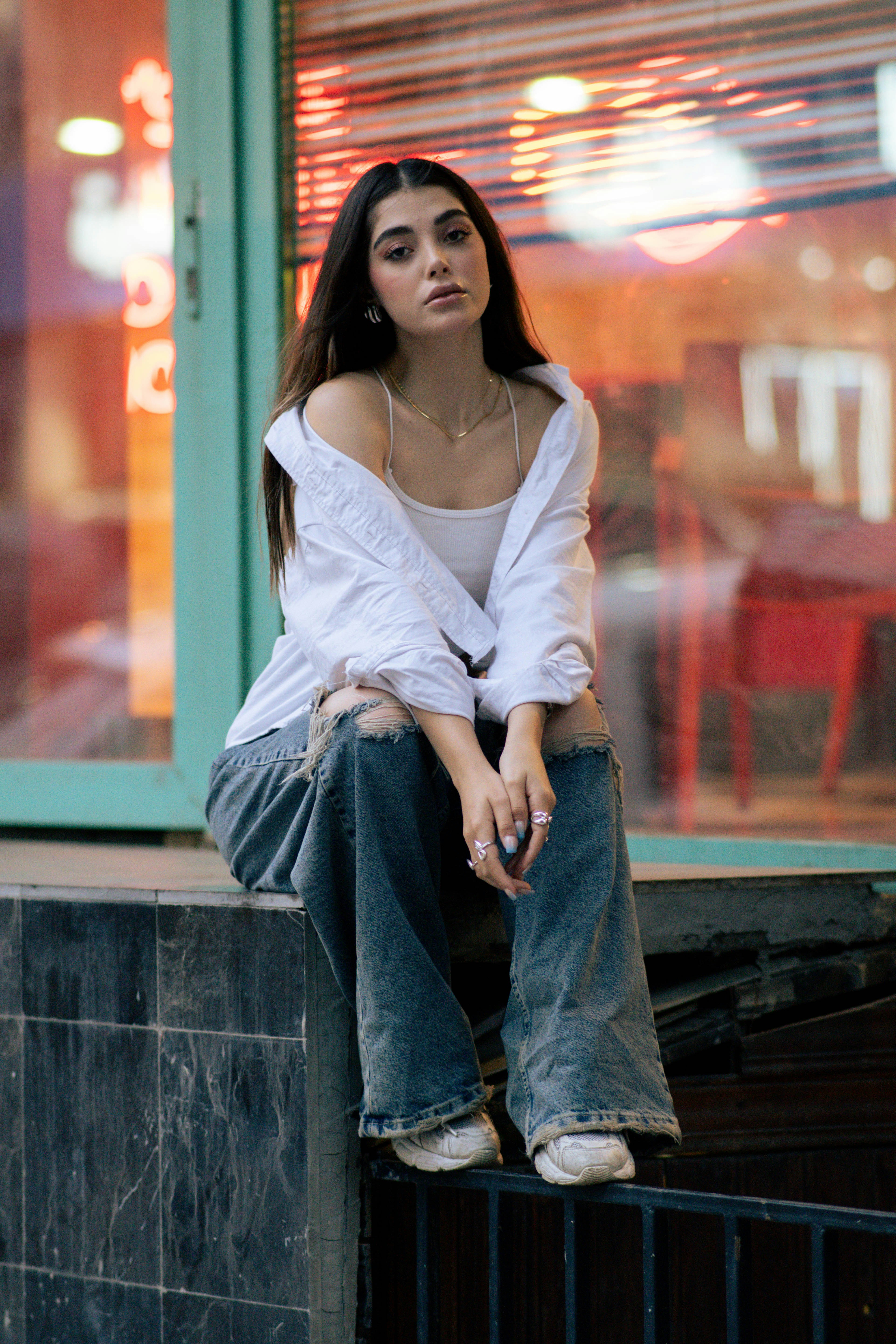 Photograph by Amin Naderloei | A young woman poses outdoors, looking at the camera.