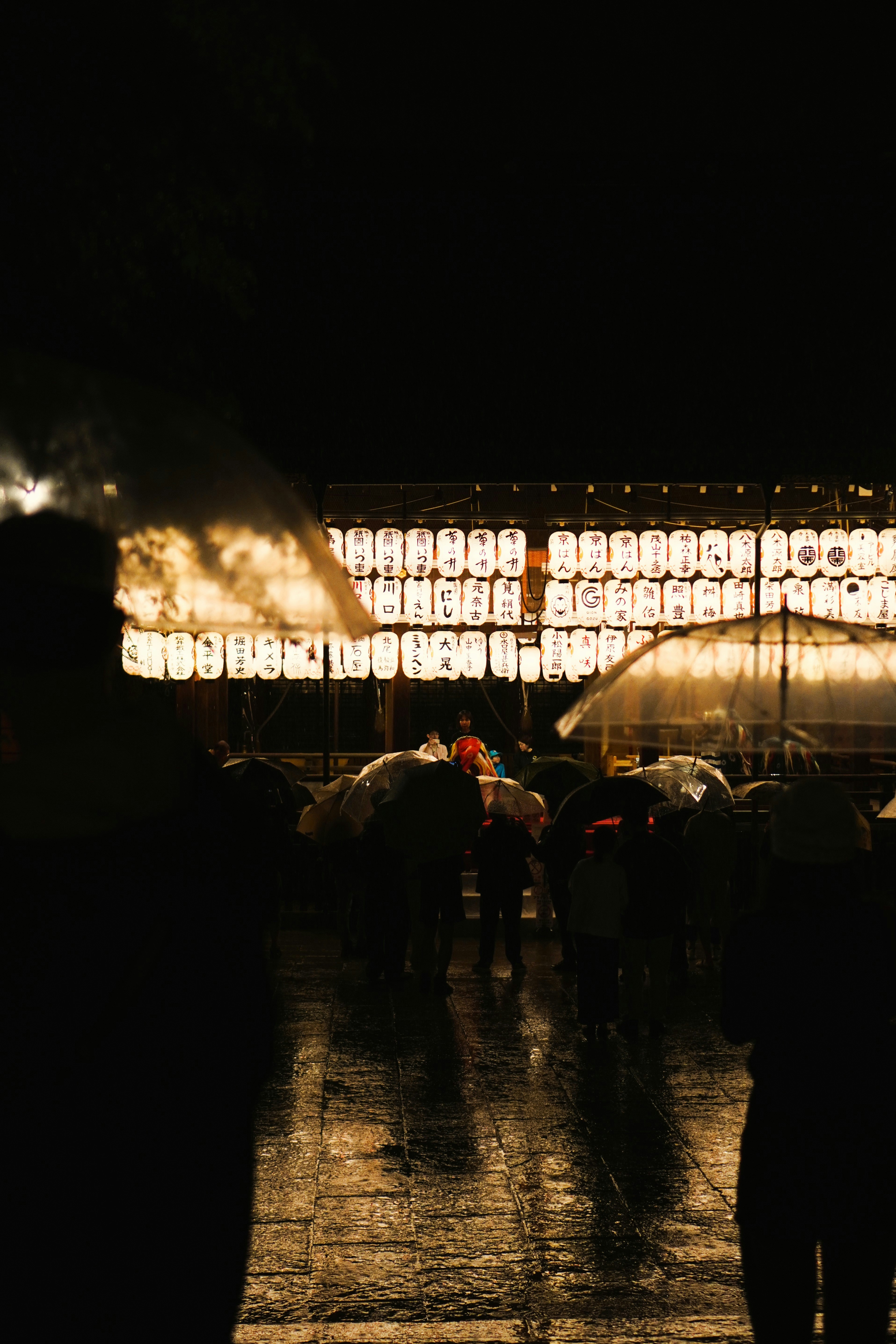 Lanterns in the Night: A Quiet Festival Under Rain-Glossed Pavement
