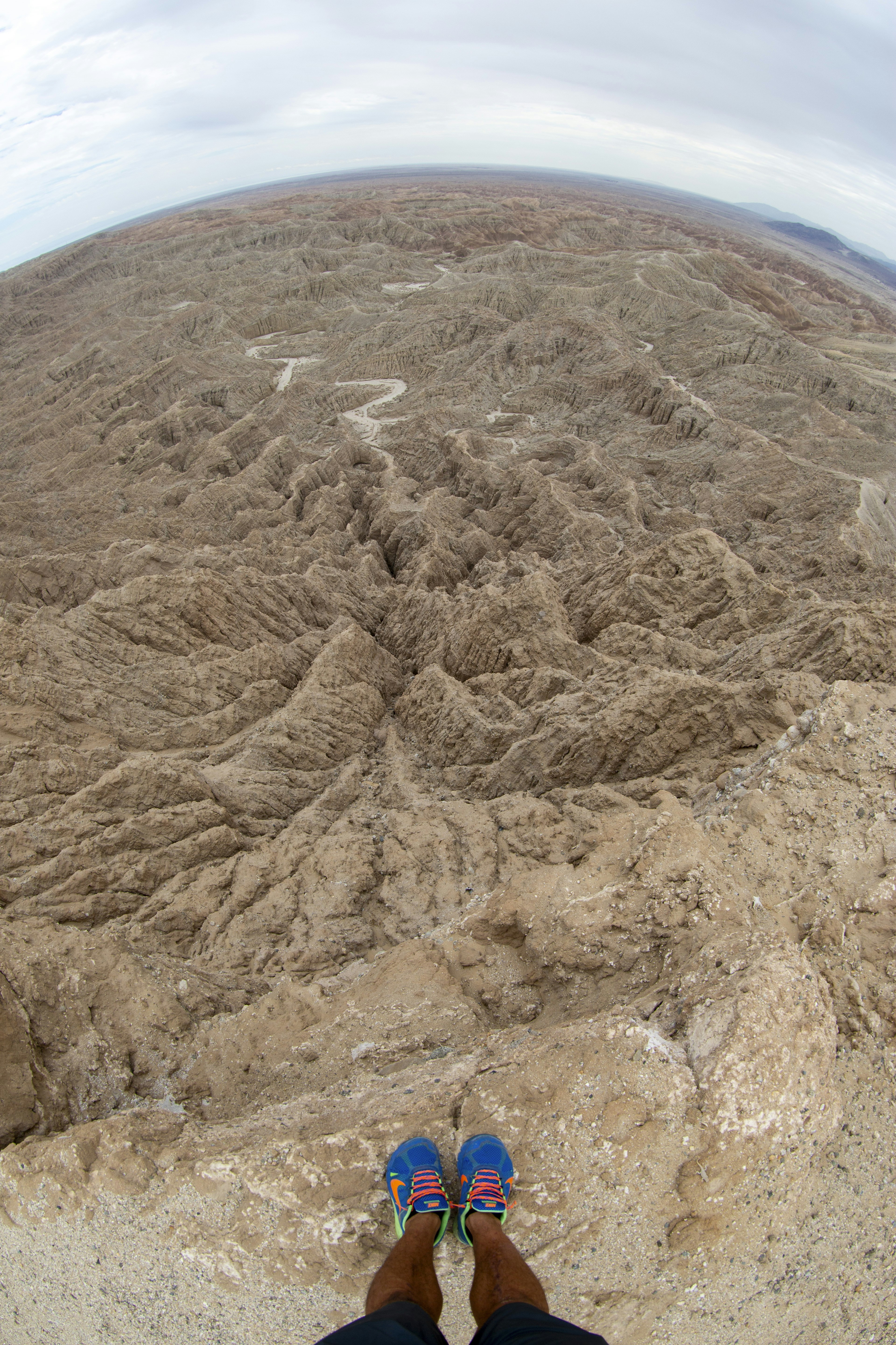 Someone is standing over a desert canyon.