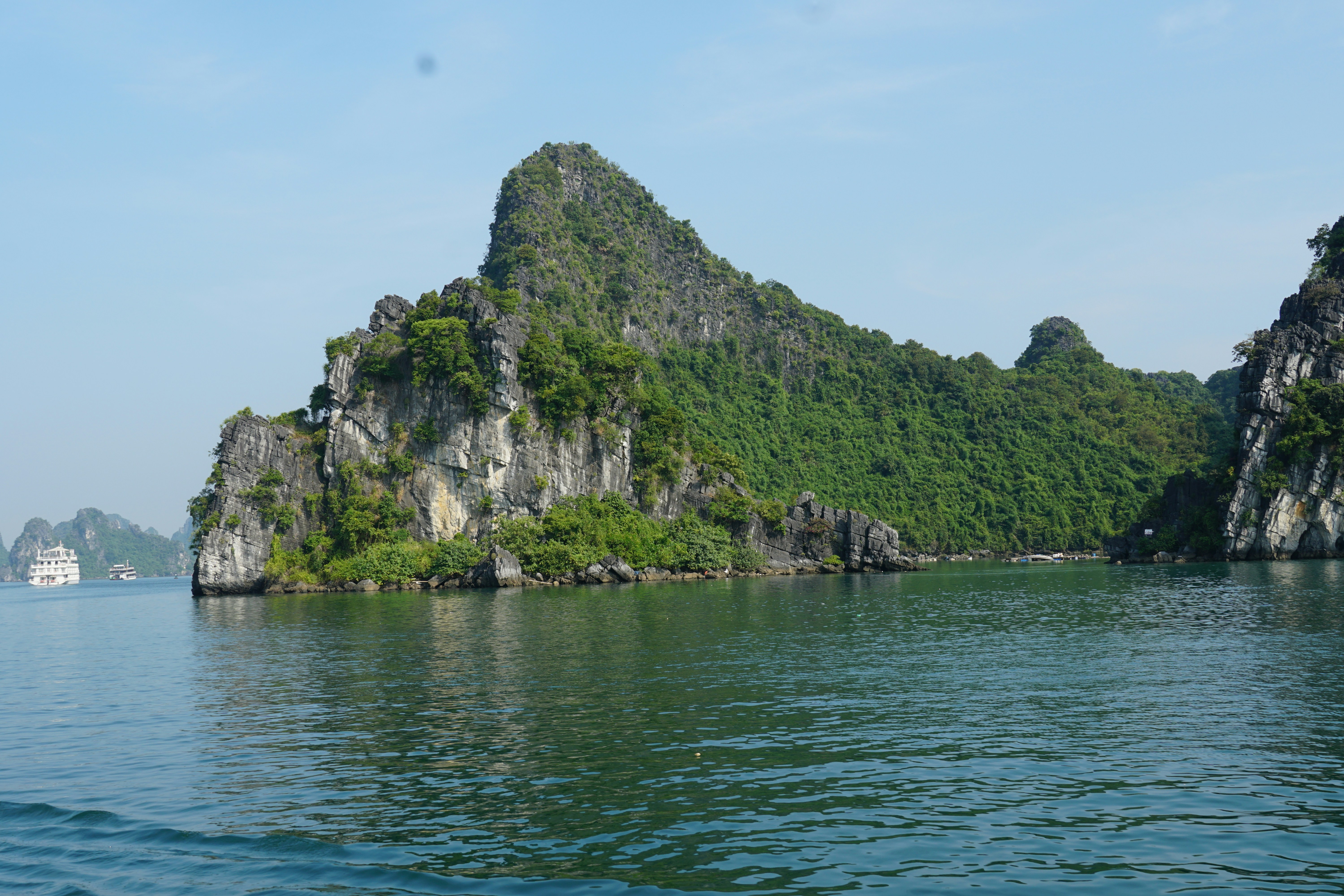 Rocky islands rise from the serene, blue water.