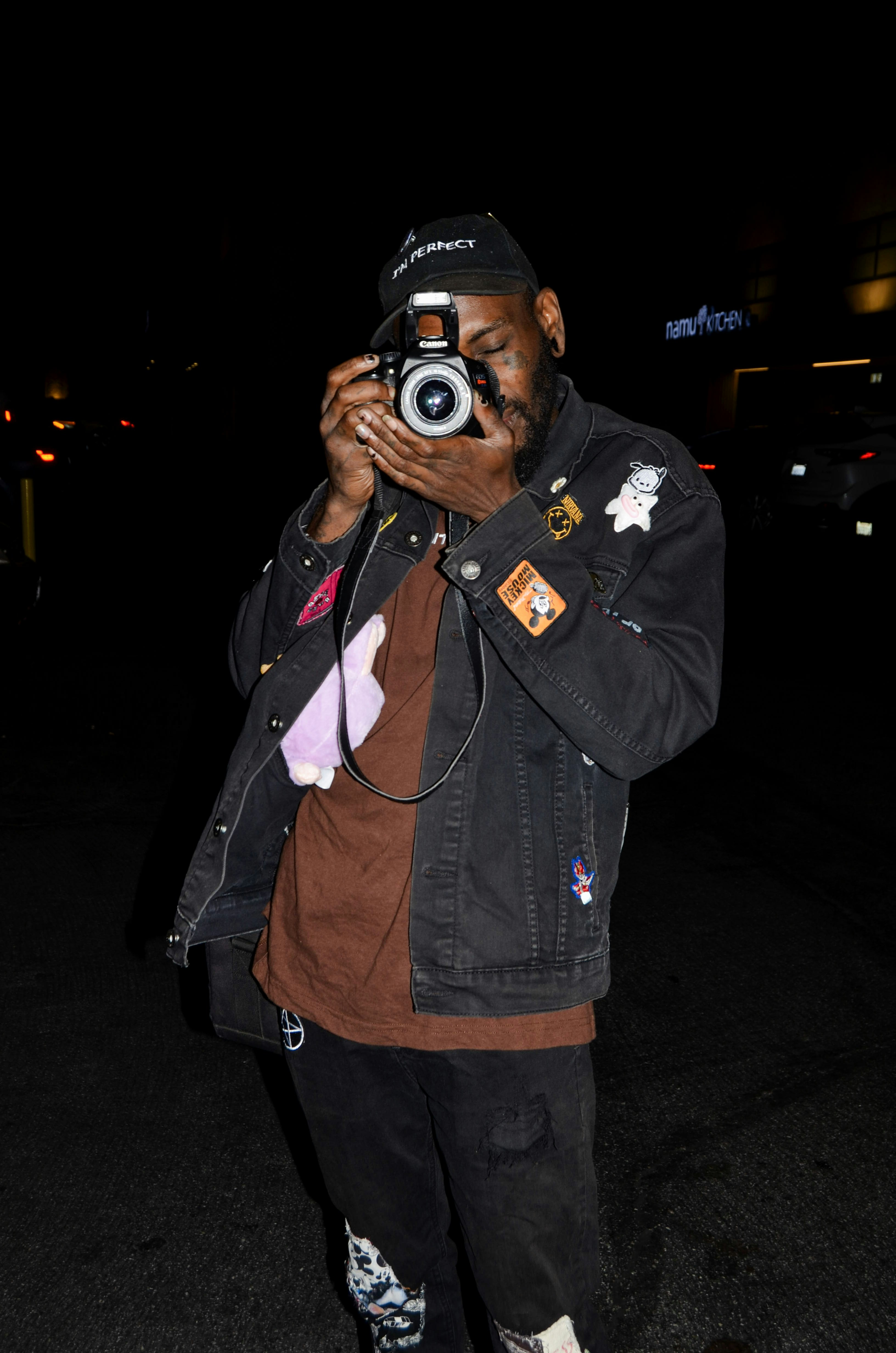 A man takes a picture with a camera.