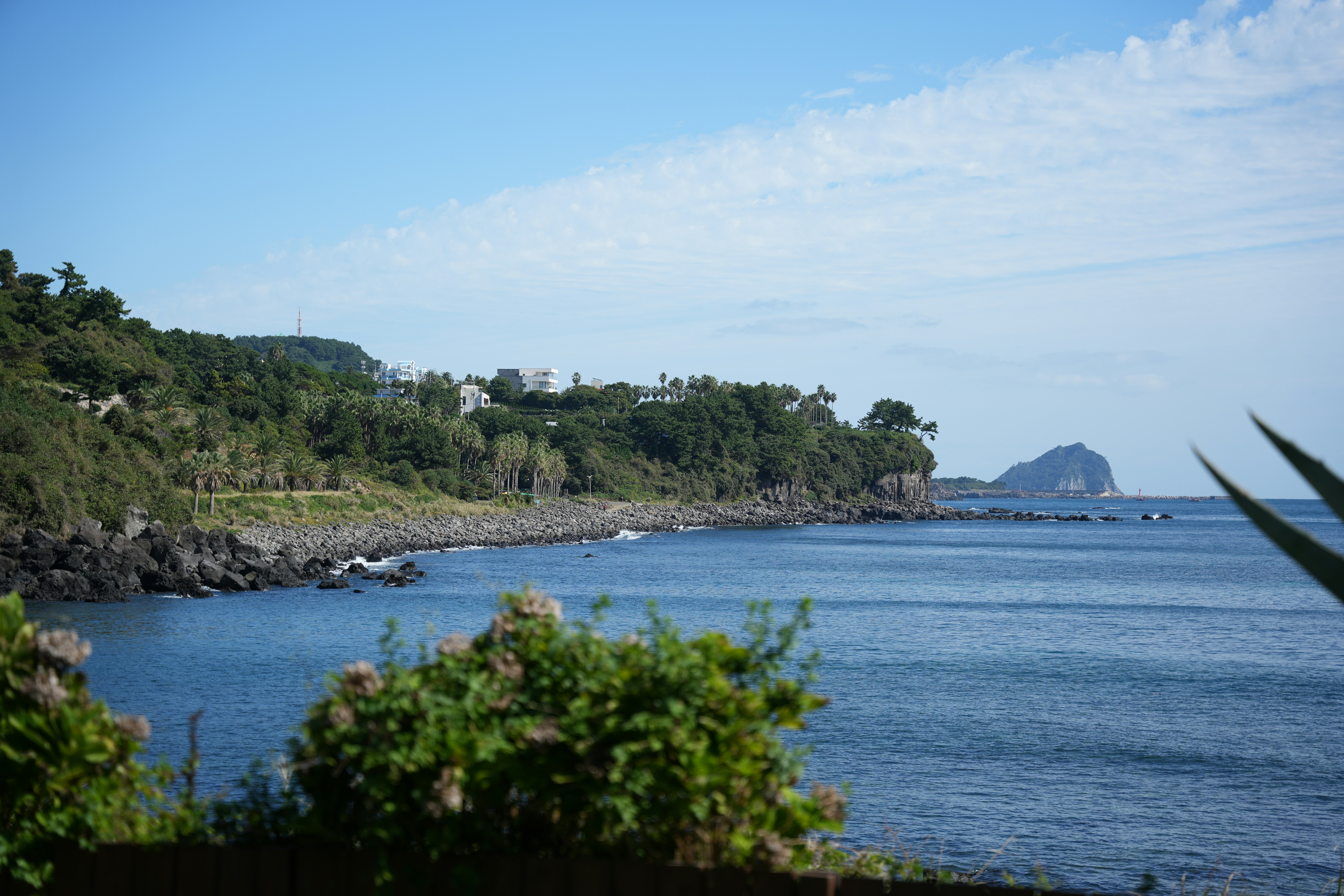 A beautiful coastline and blue ocean under sunny skies.